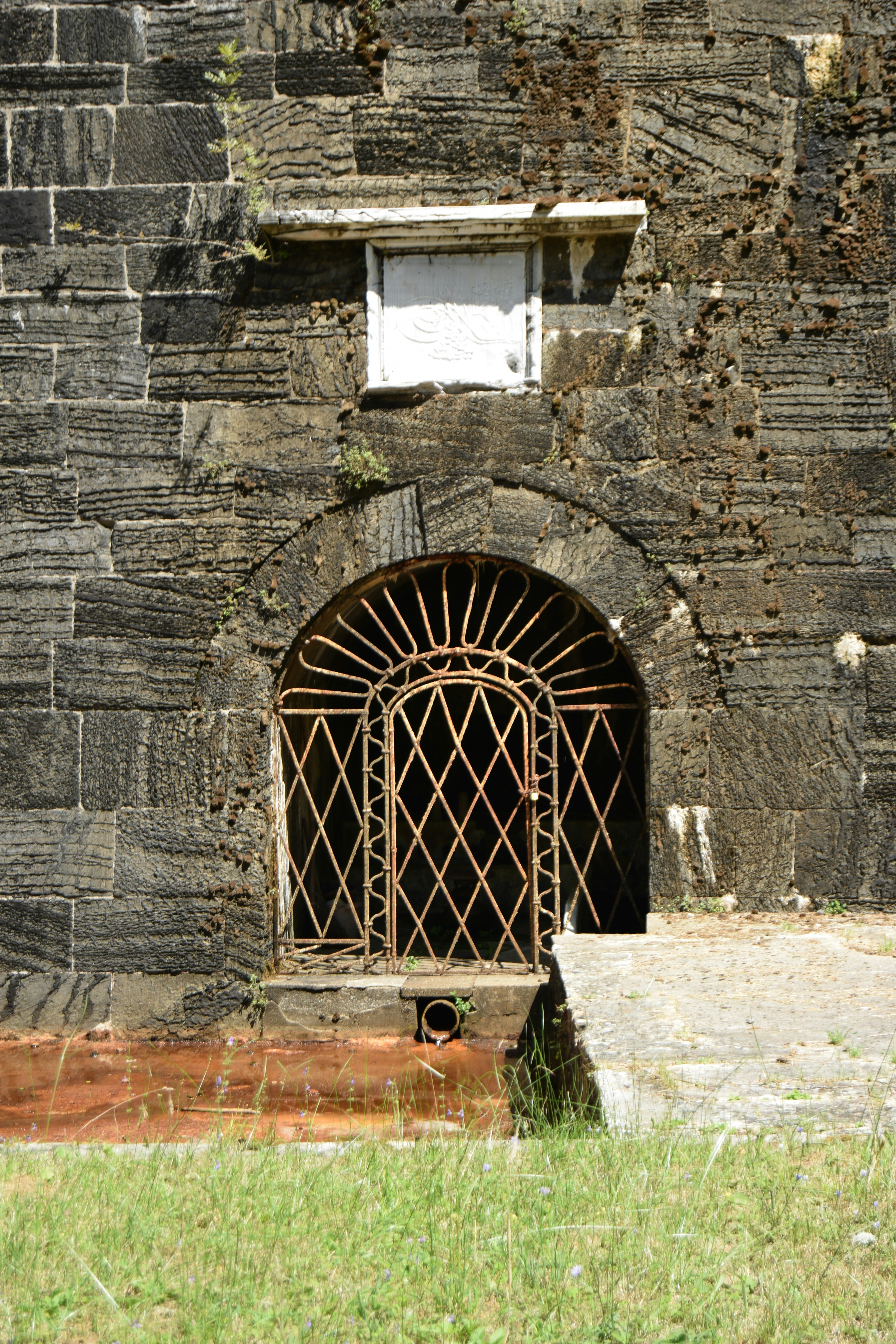 Arched Iron Gate in a Timeworn Bastion