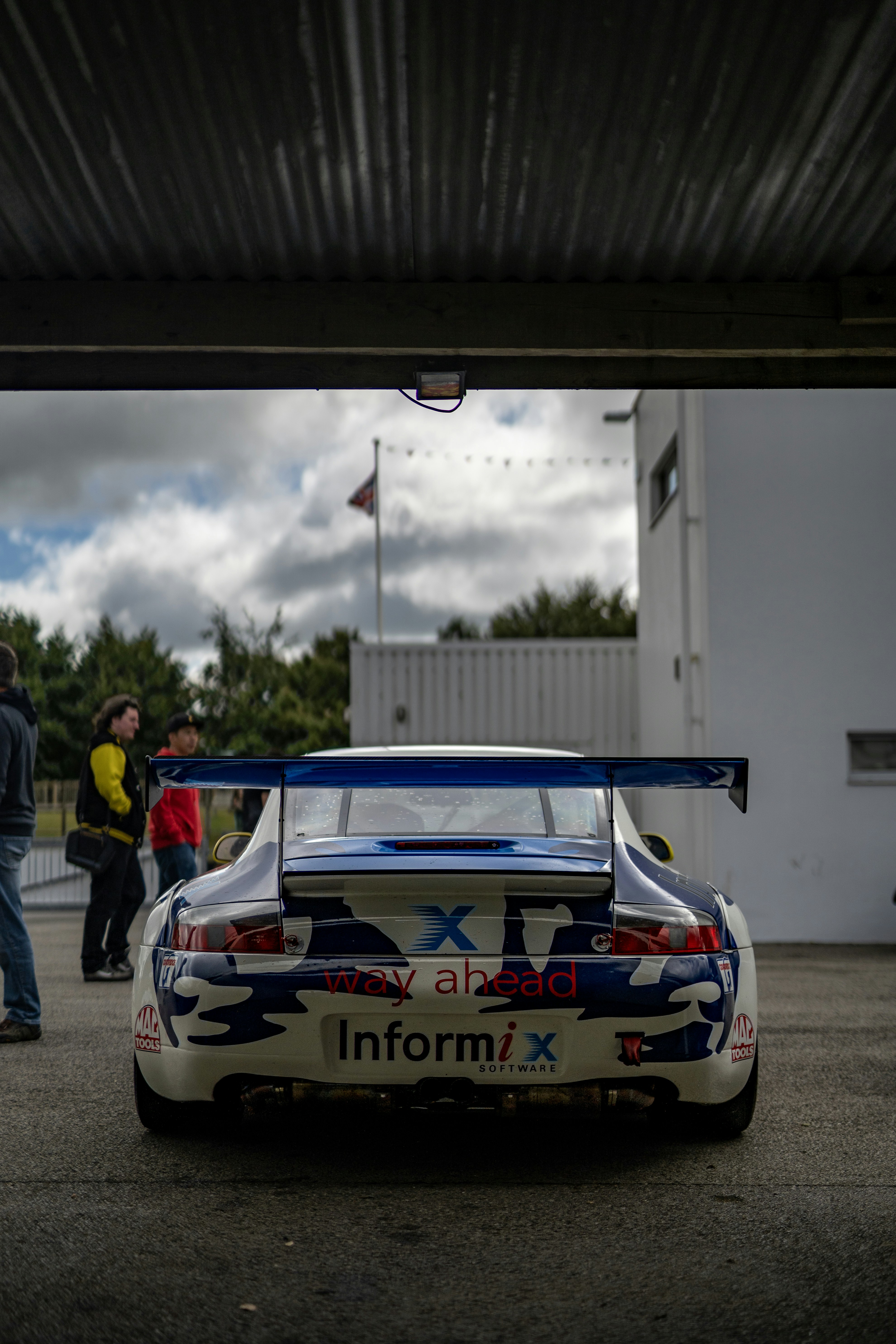 Rear-Quarter Racing Stance: Informix Livery and Blue Wing
