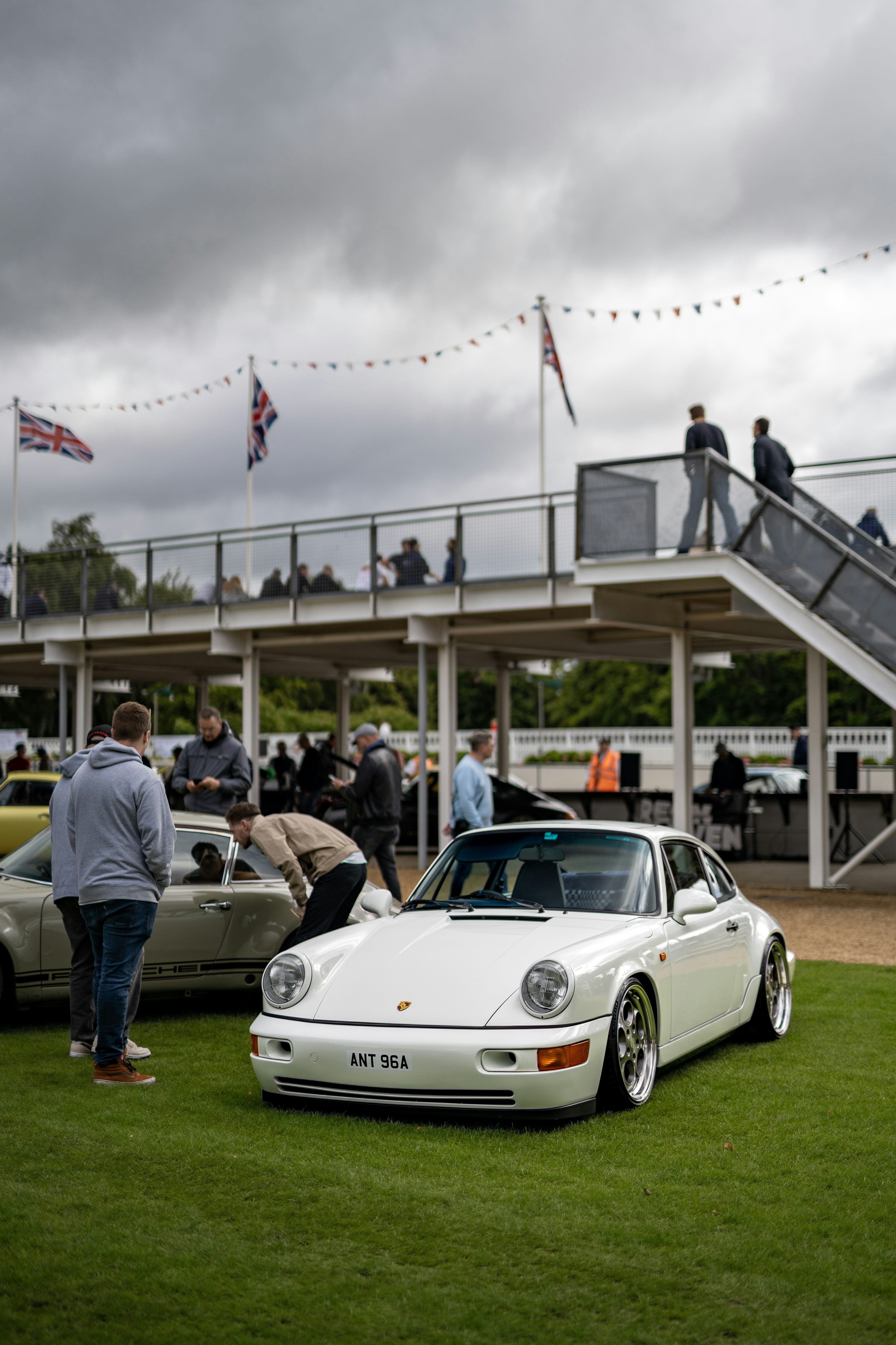 A group of people standing around a white car photo – Free Gt4rs Image ...