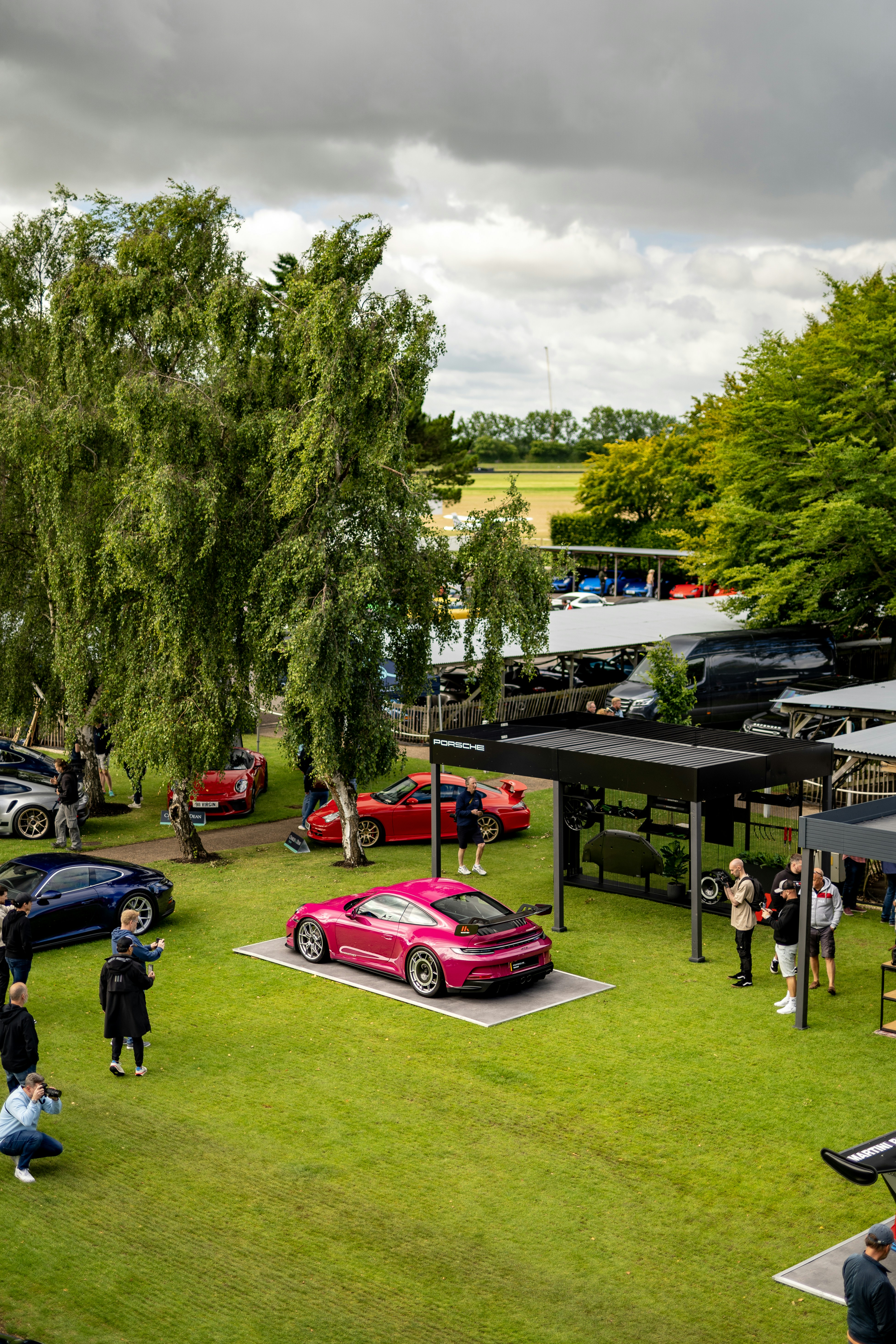 Pink Porsche on a manicured lawn steals the show at a community car gathering