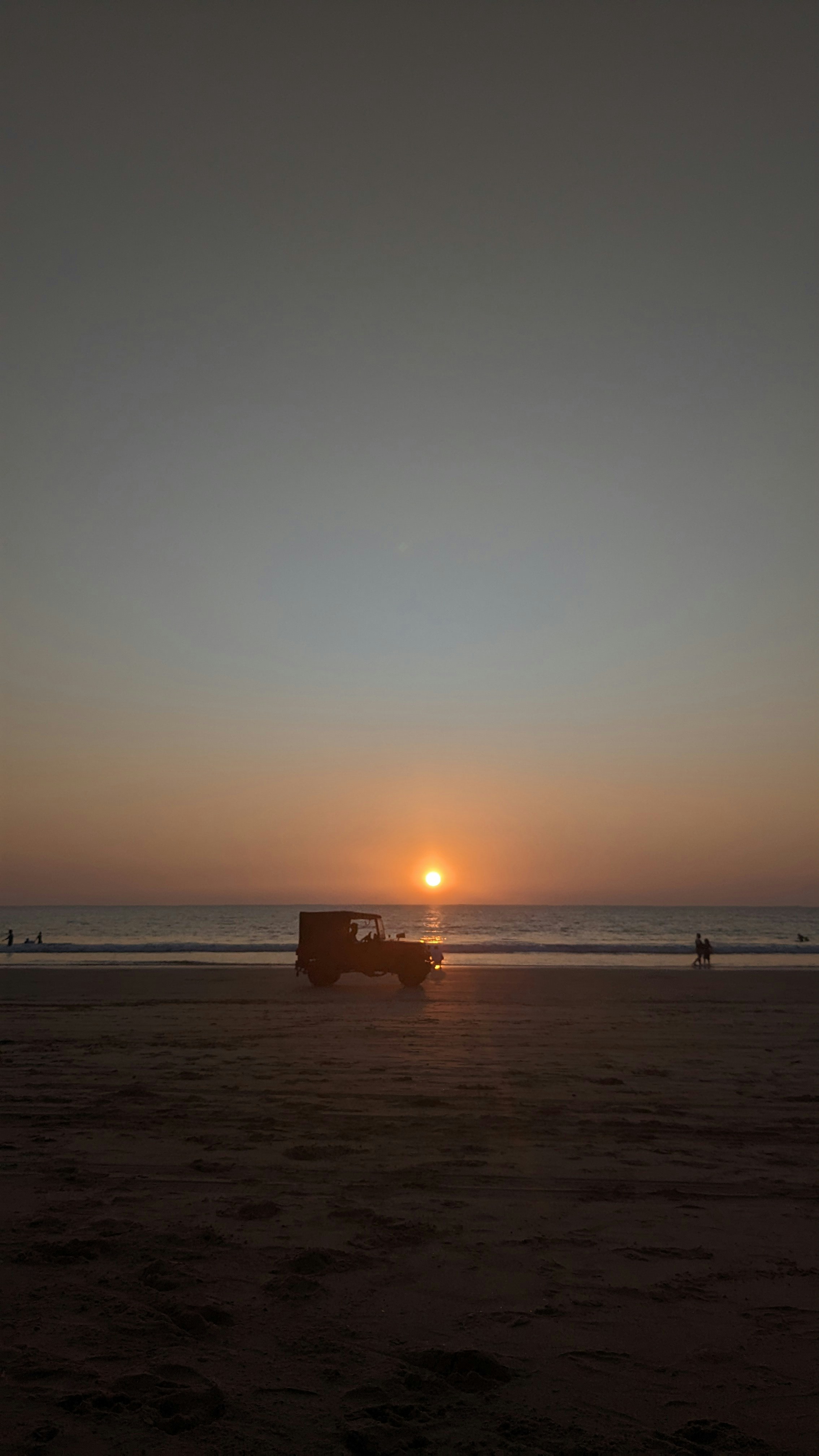 Sunlit Jeep on the Quiet Beach at Sunset