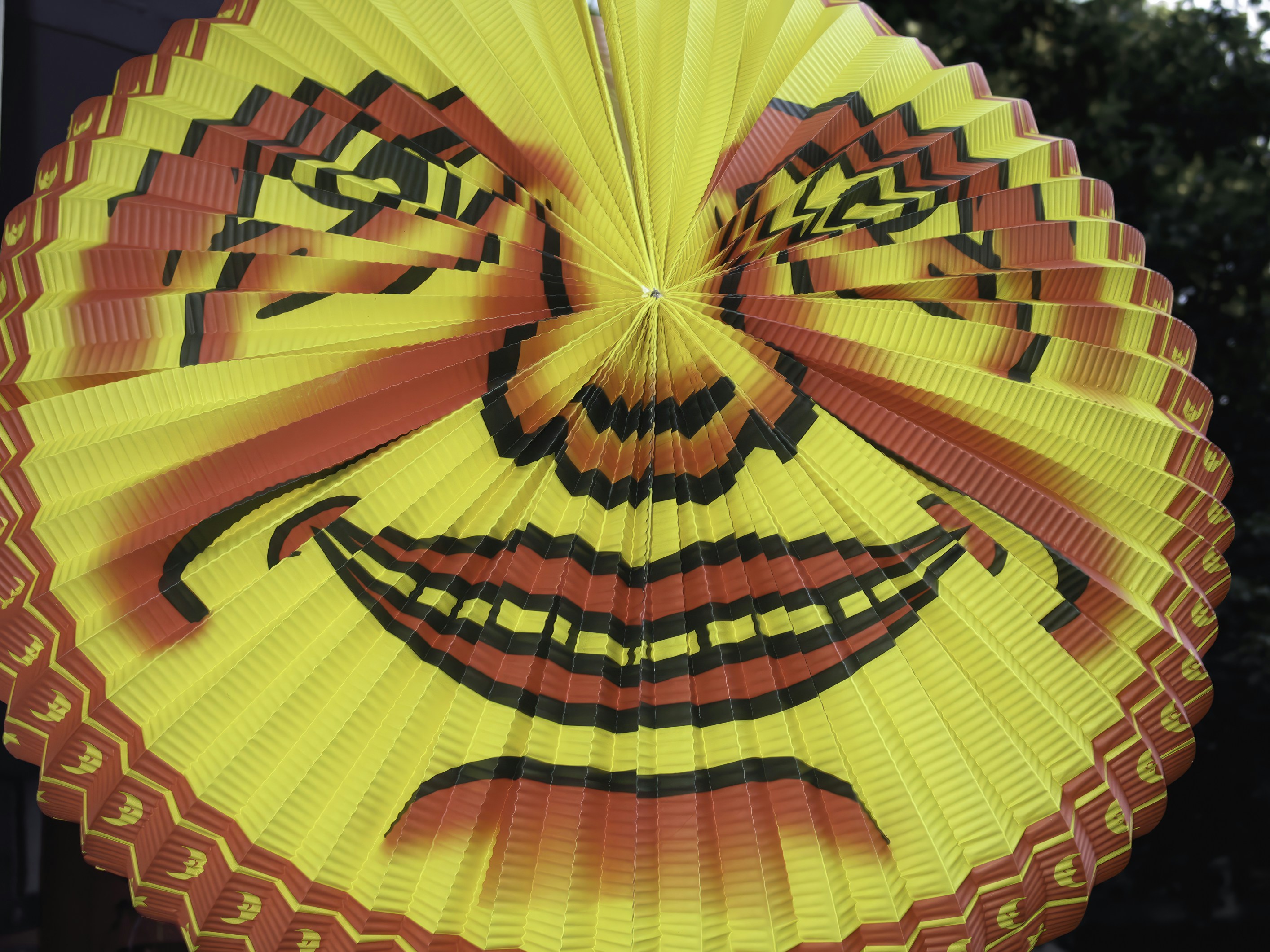 A close up of a paper fan with a clown face on it photo – Free Martha's ...