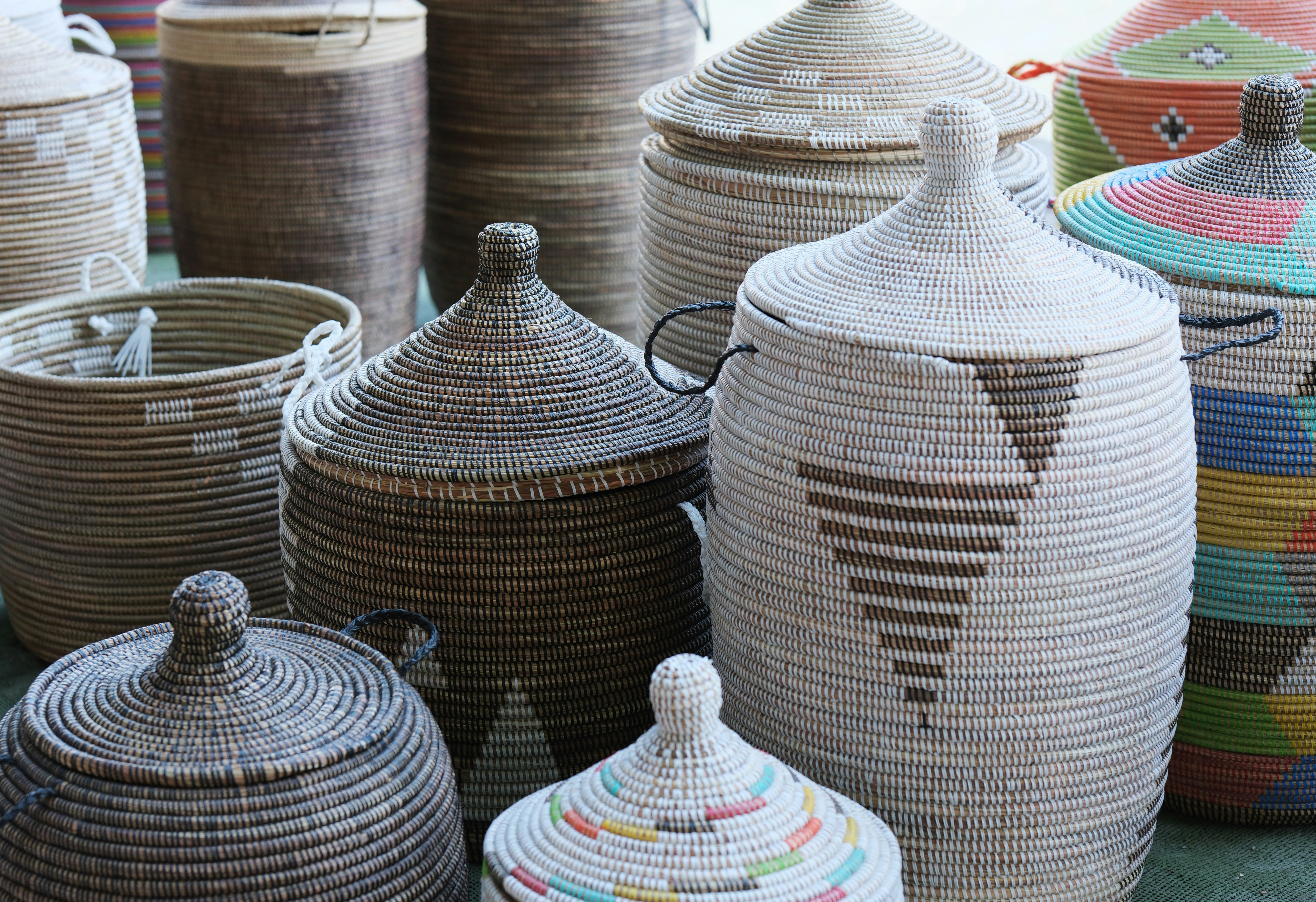 Intricately woven baskets showcasing a variety of patterns and colors, arranged artistically. Each basket reflects the craftsmanship of traditional weaving techniques.