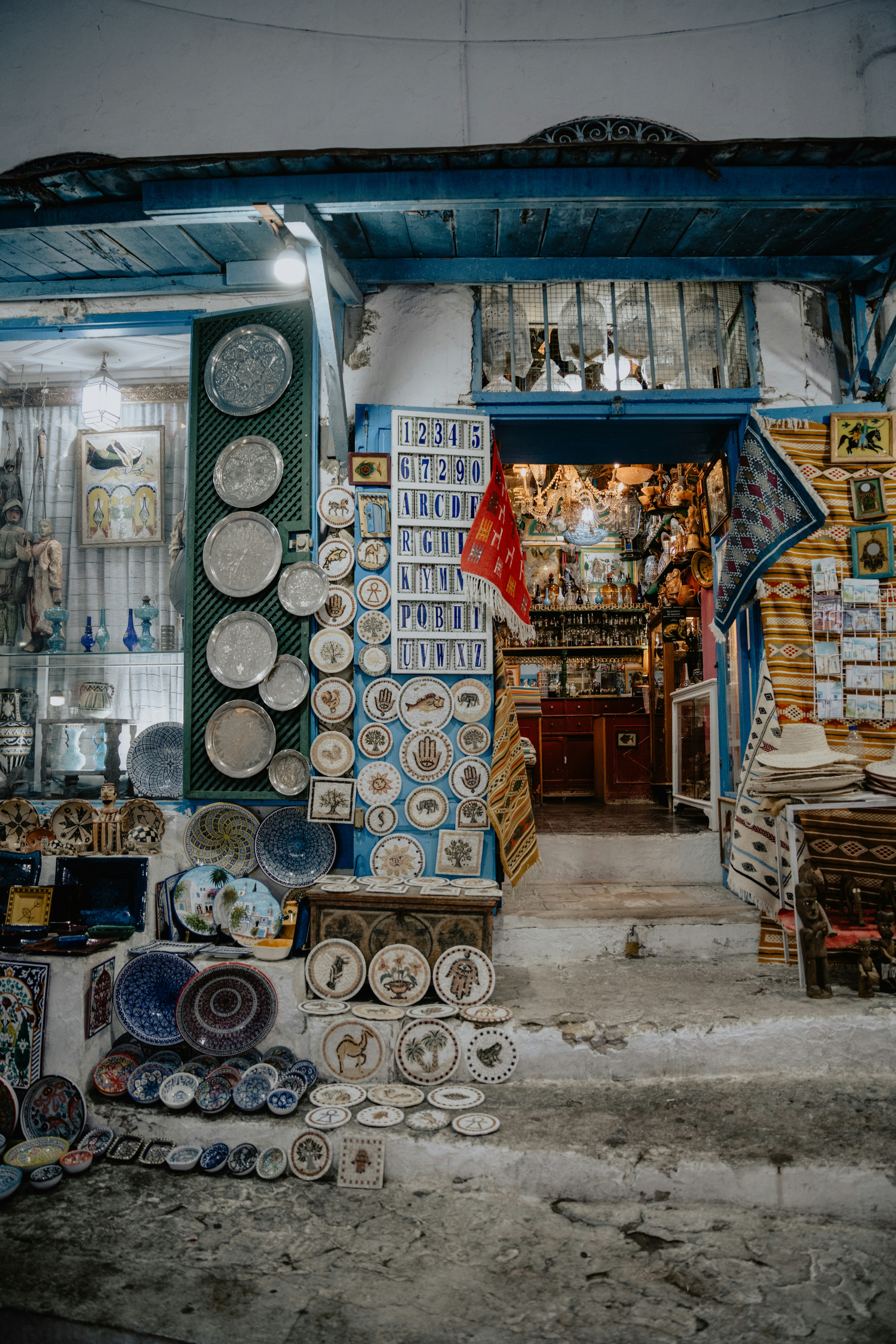 A store with a lot of plates on display photo – Free Architecture Image ...