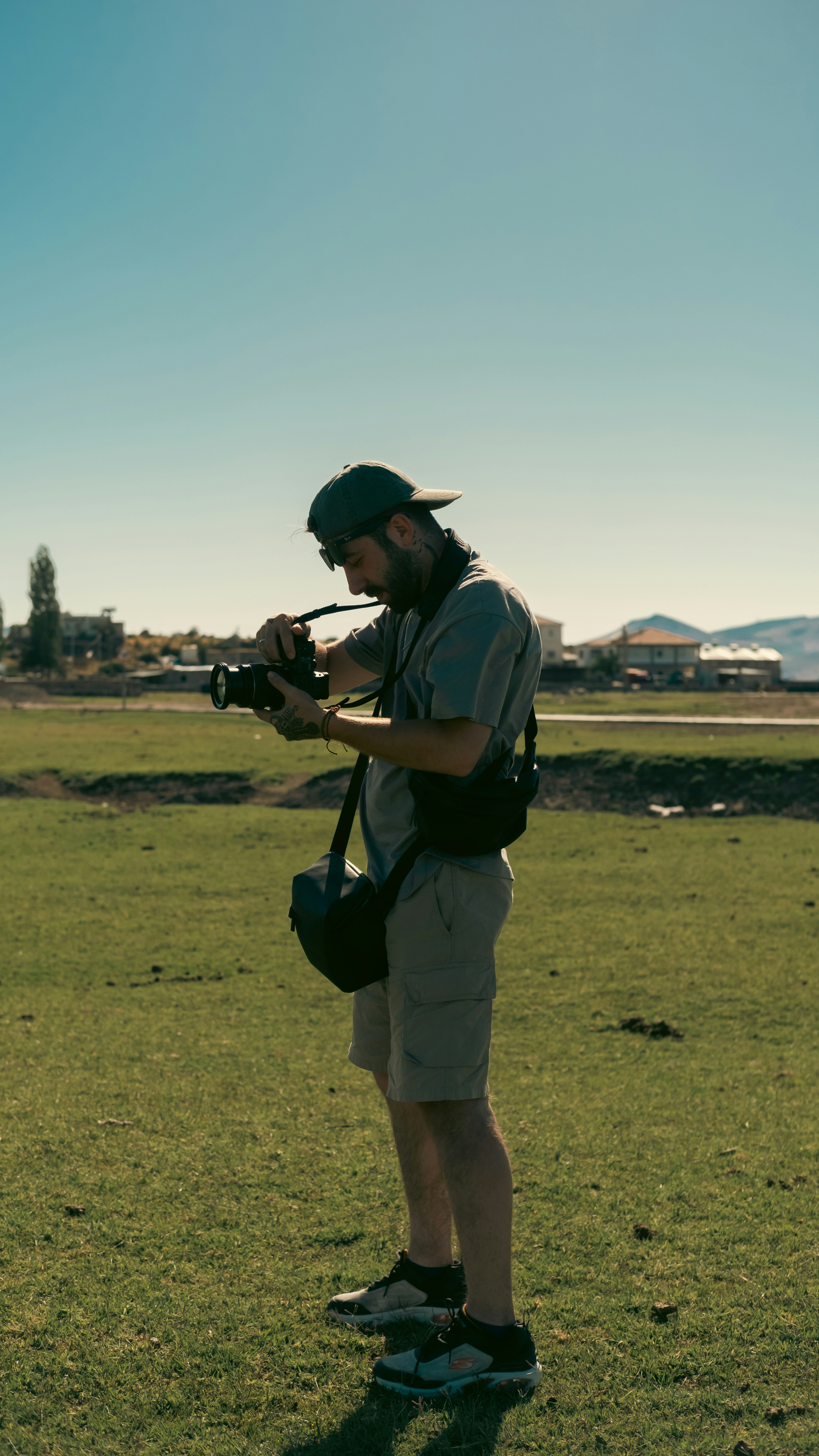 A man standing in a field holding a camera photo – Free Kayseri Image ...