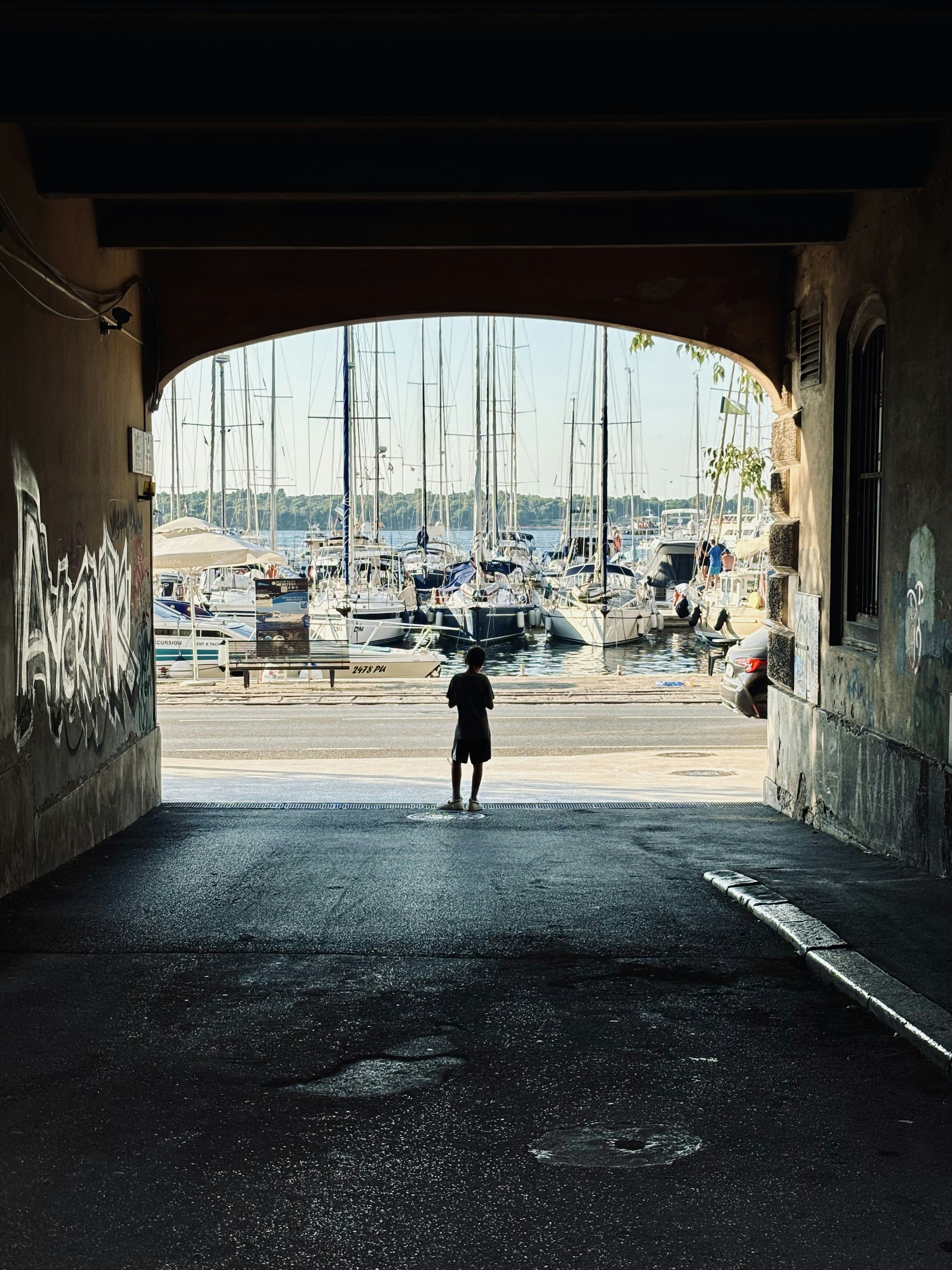 Threshold of Light: A Solitary Figure Framing the Marina
