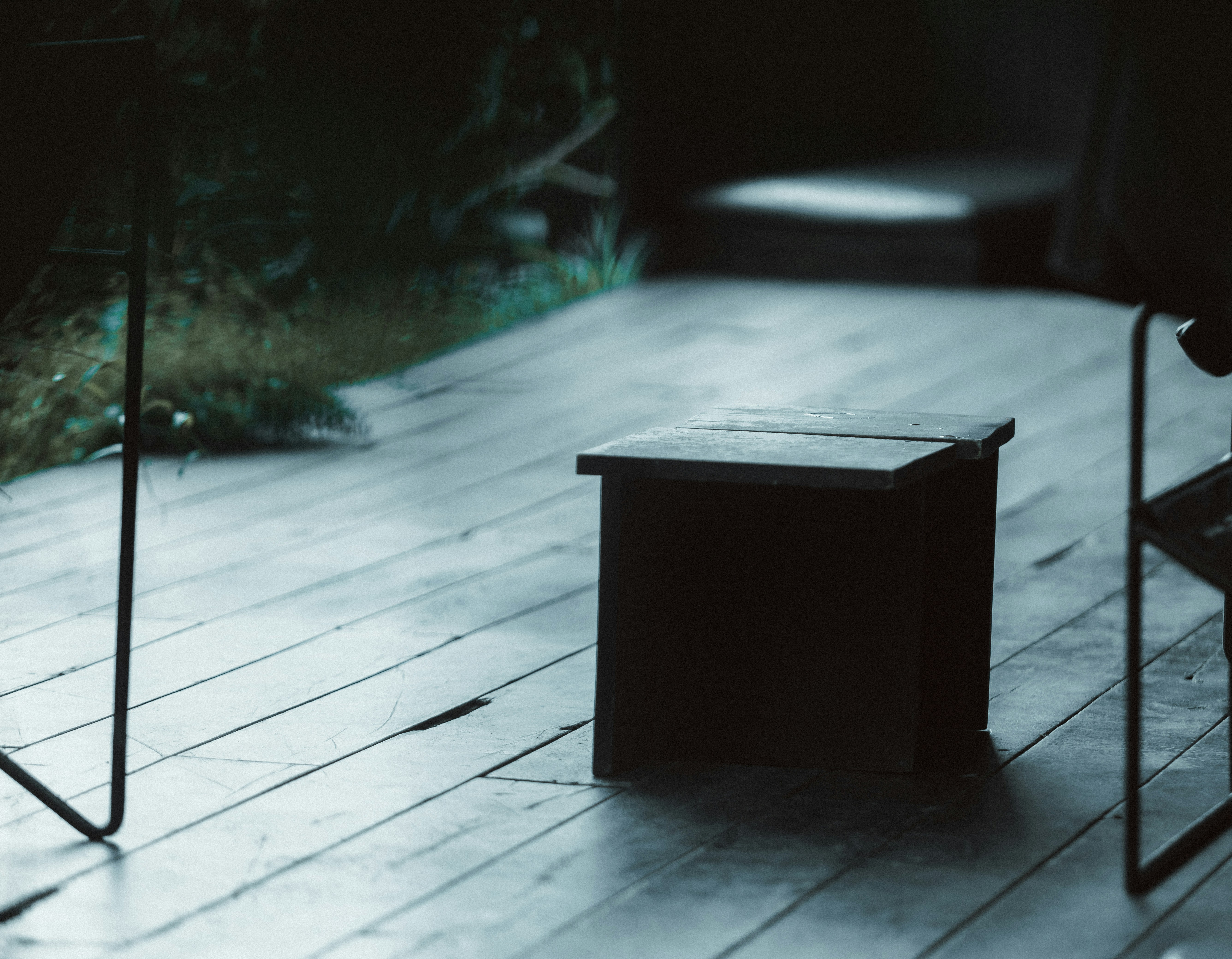 Lone Stool on a Dim Deck, under a Cool Blue Glow