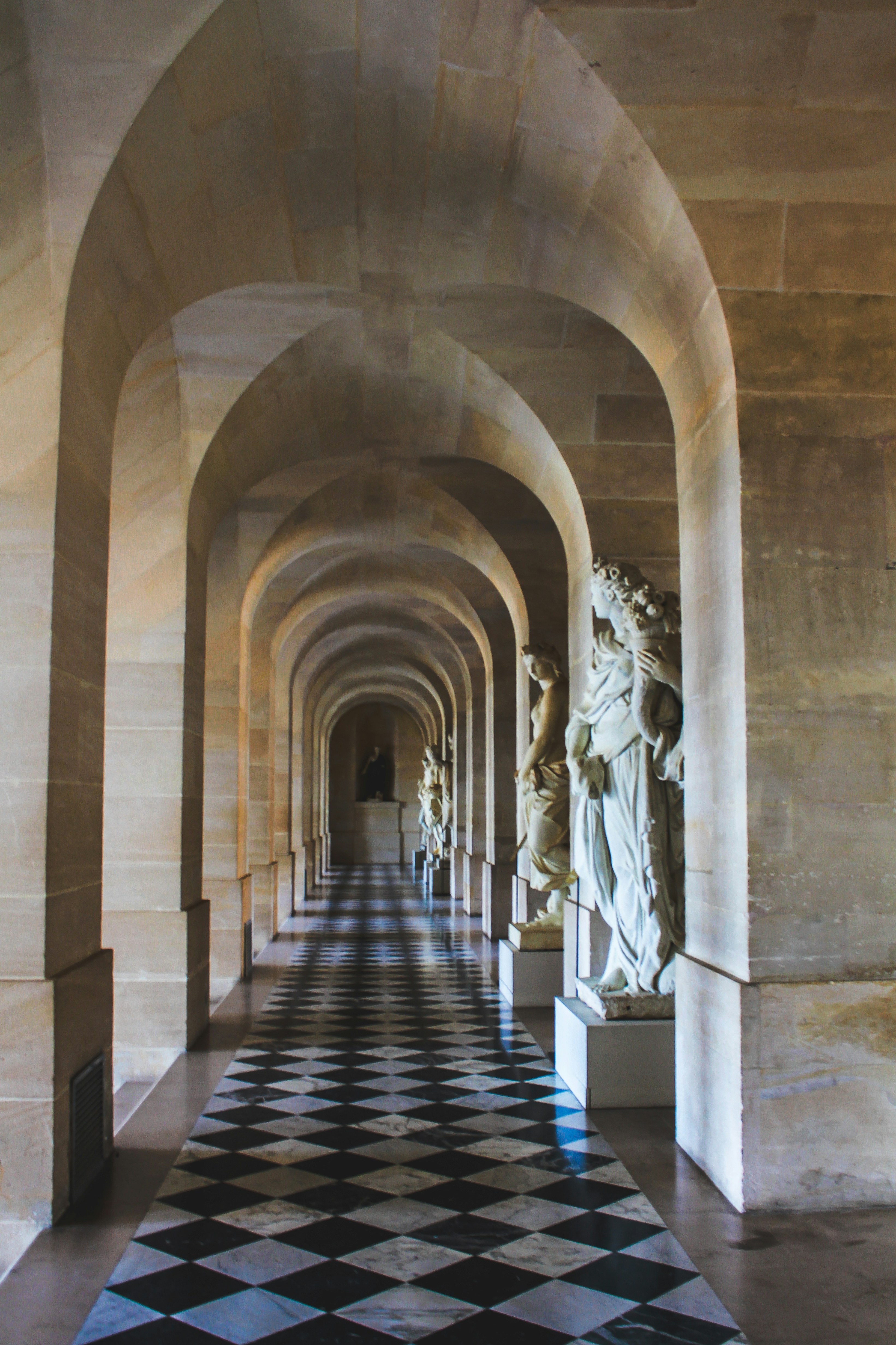 A long hallway with statues on either side of it photo – Free Museum ...