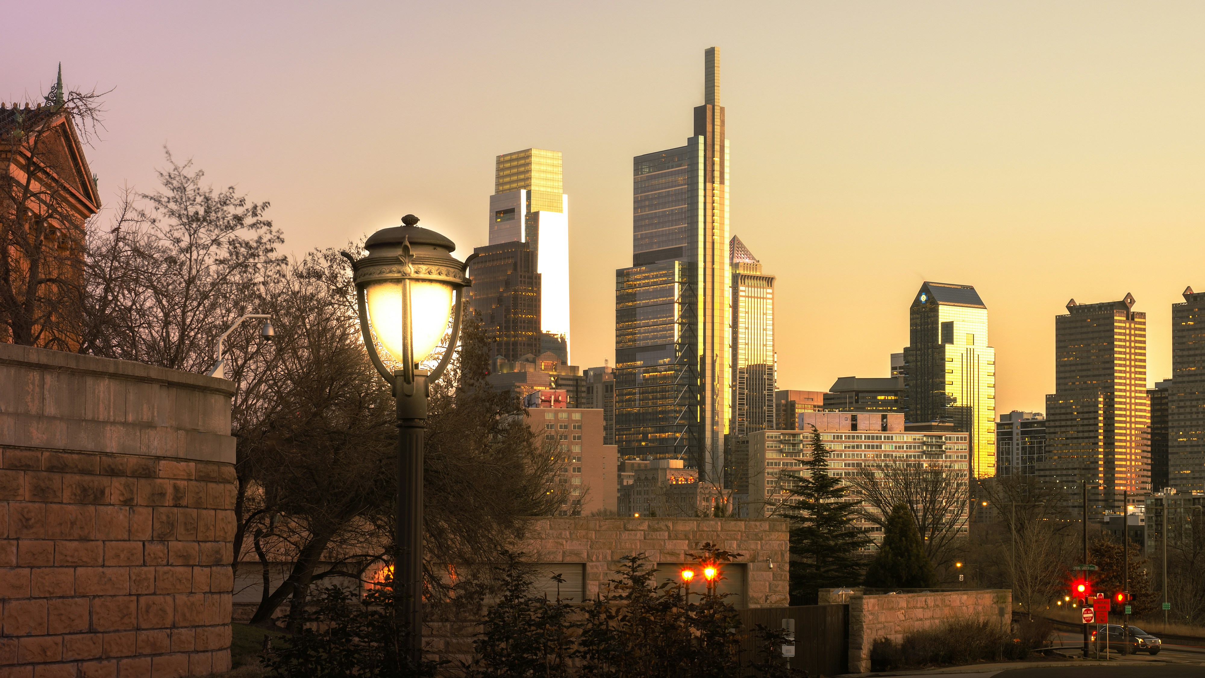 Philadelphia skyline bathed in warm sunset hues, viewed from the Philadelphia Museum of Art.