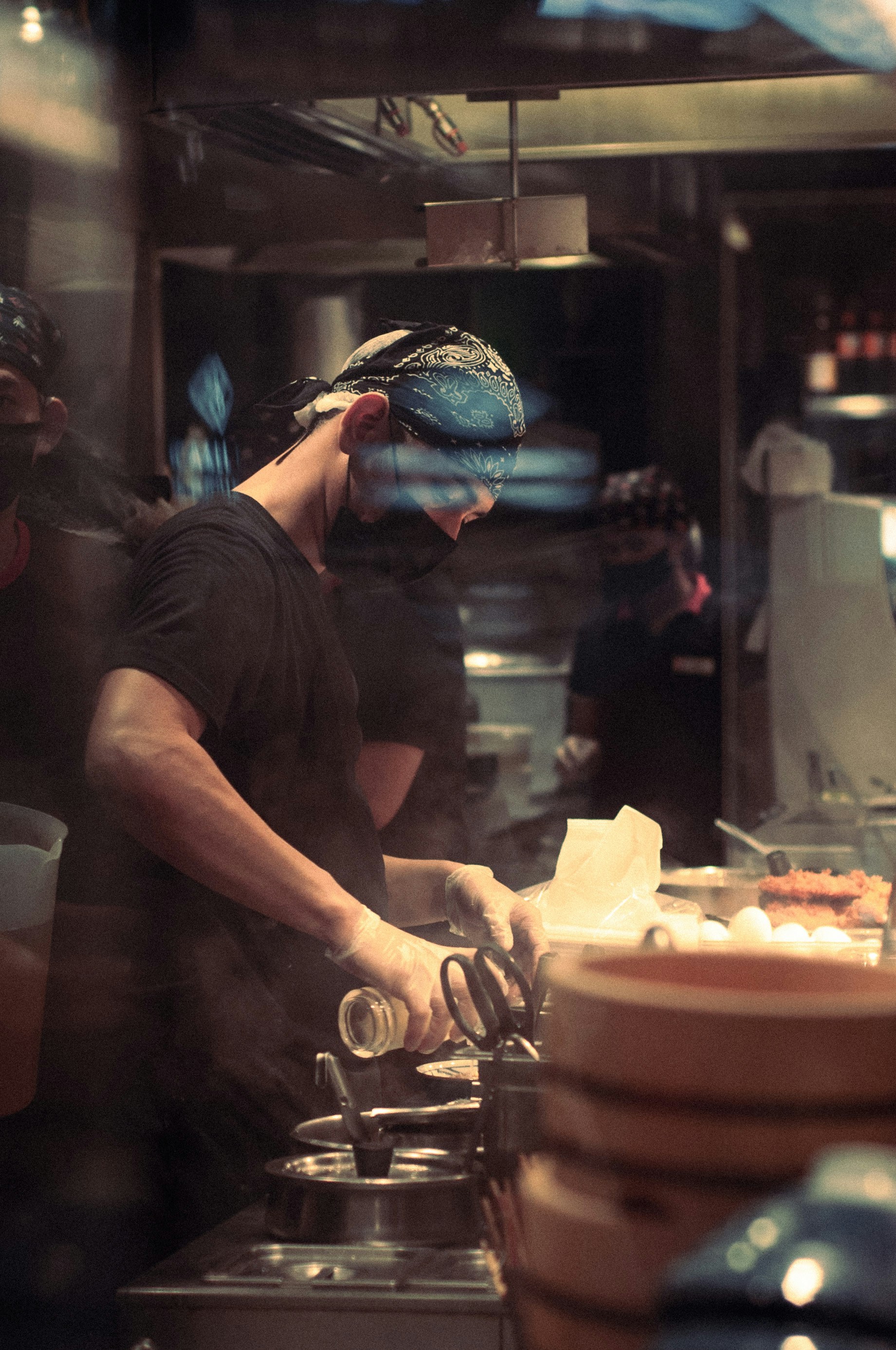 Chef skillfully preparing dishes in a bustling kitchen, surrounded by vibrant ingredients and tools. The scene captures the essence of culinary artistry.