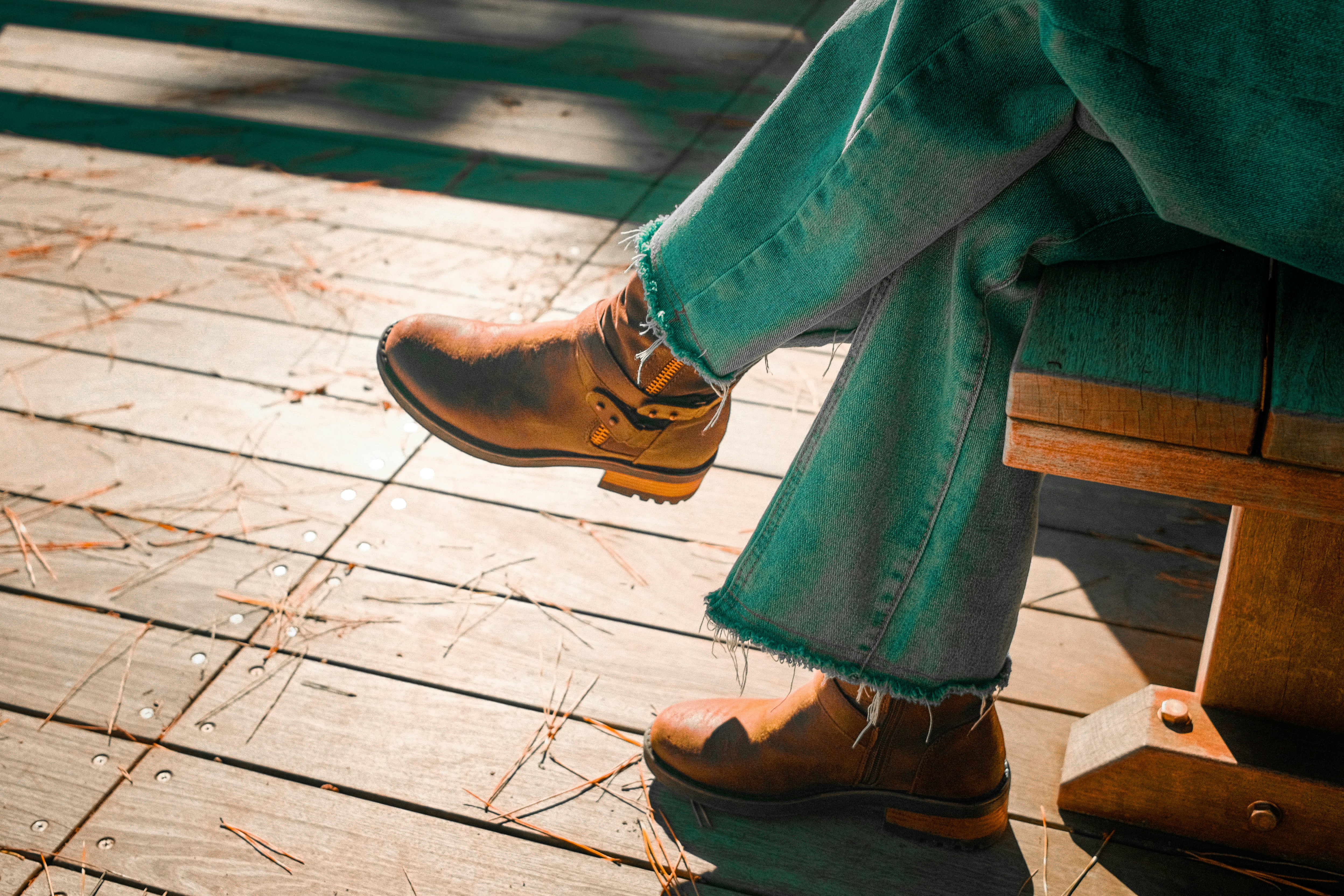 Boots at the Edge of a Sunlit Deck