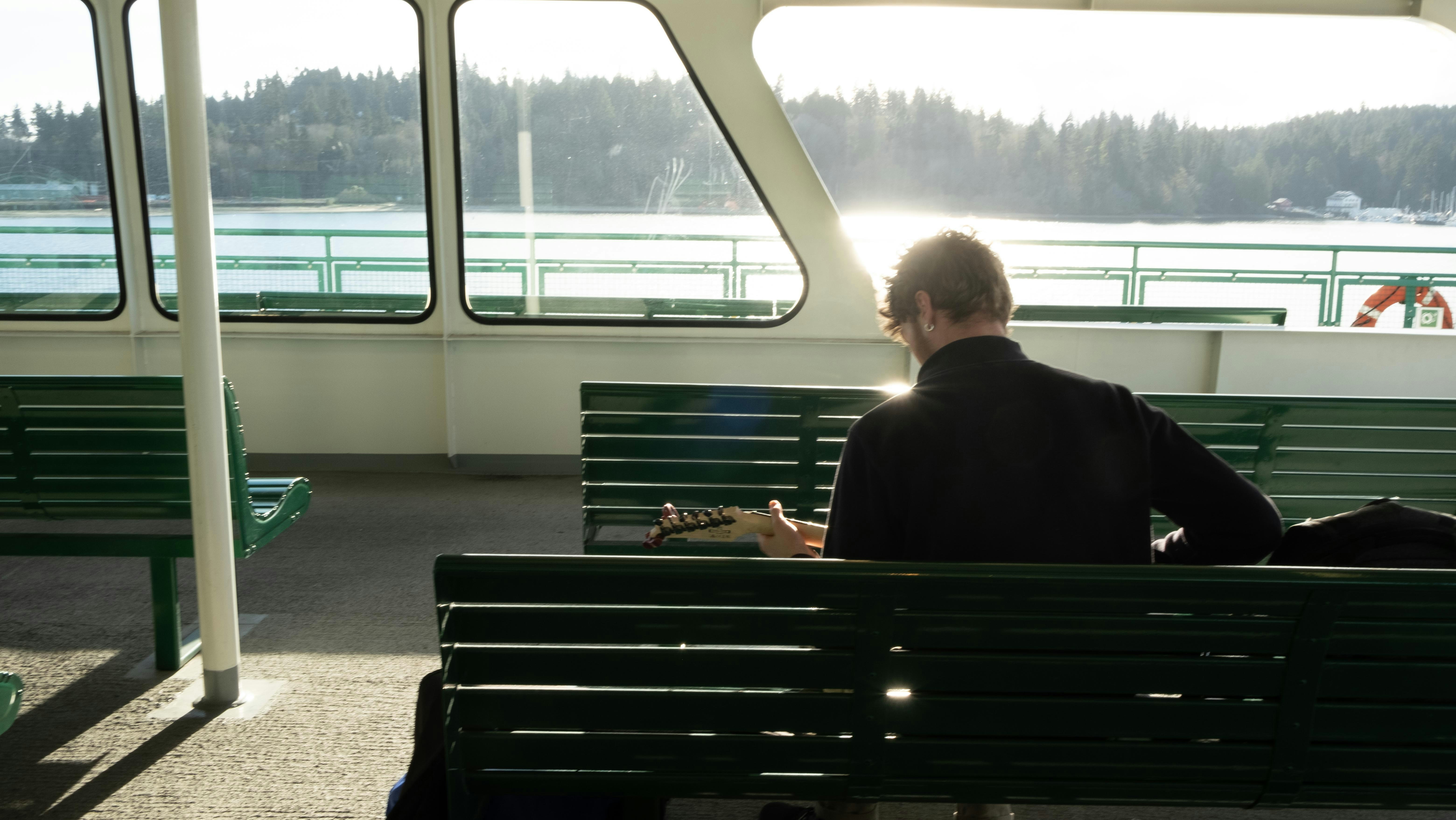 Guitar at Dusk: A Quiet Portrait on the Transit Terrace