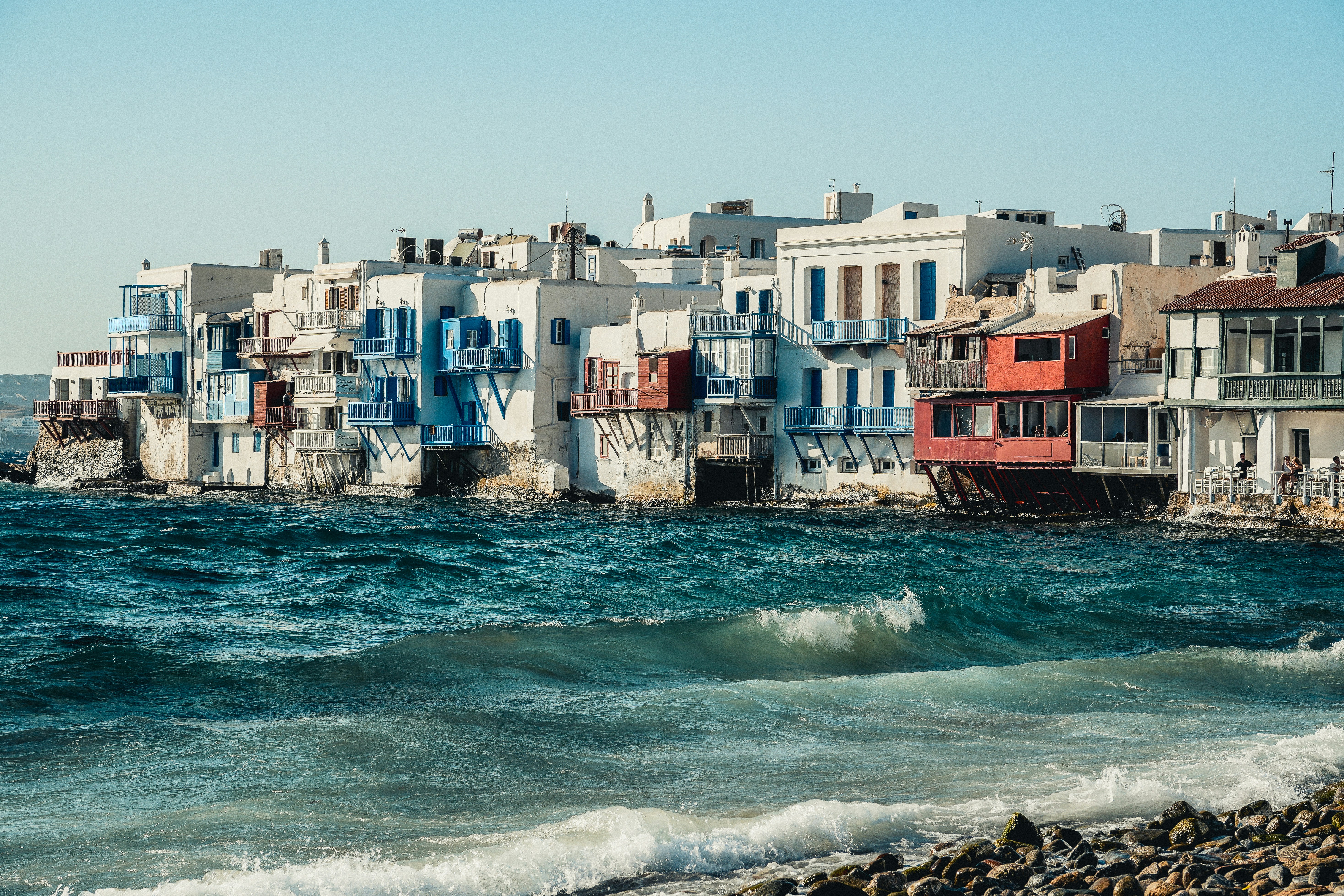 Color Corridor by the Sea: Painted Seafront Homes Clinging to a Rocky Shore