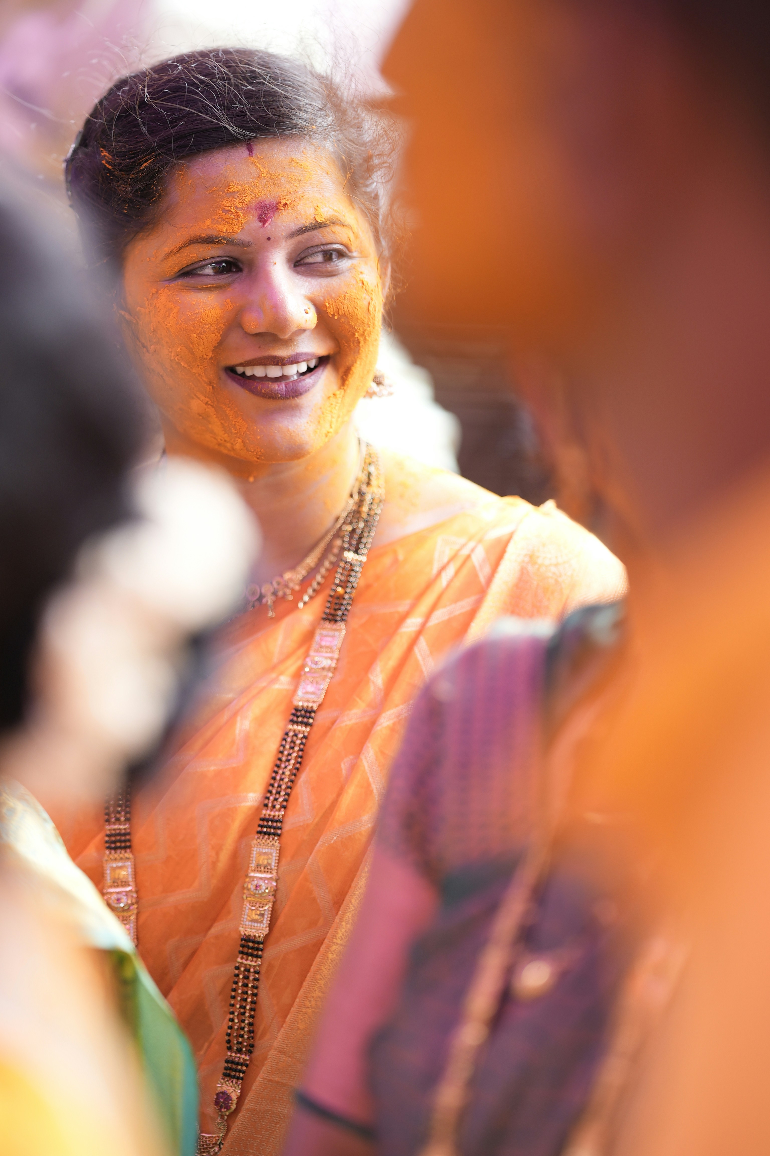 Holi Glow: A Warm Smile Framed by Orange Dust