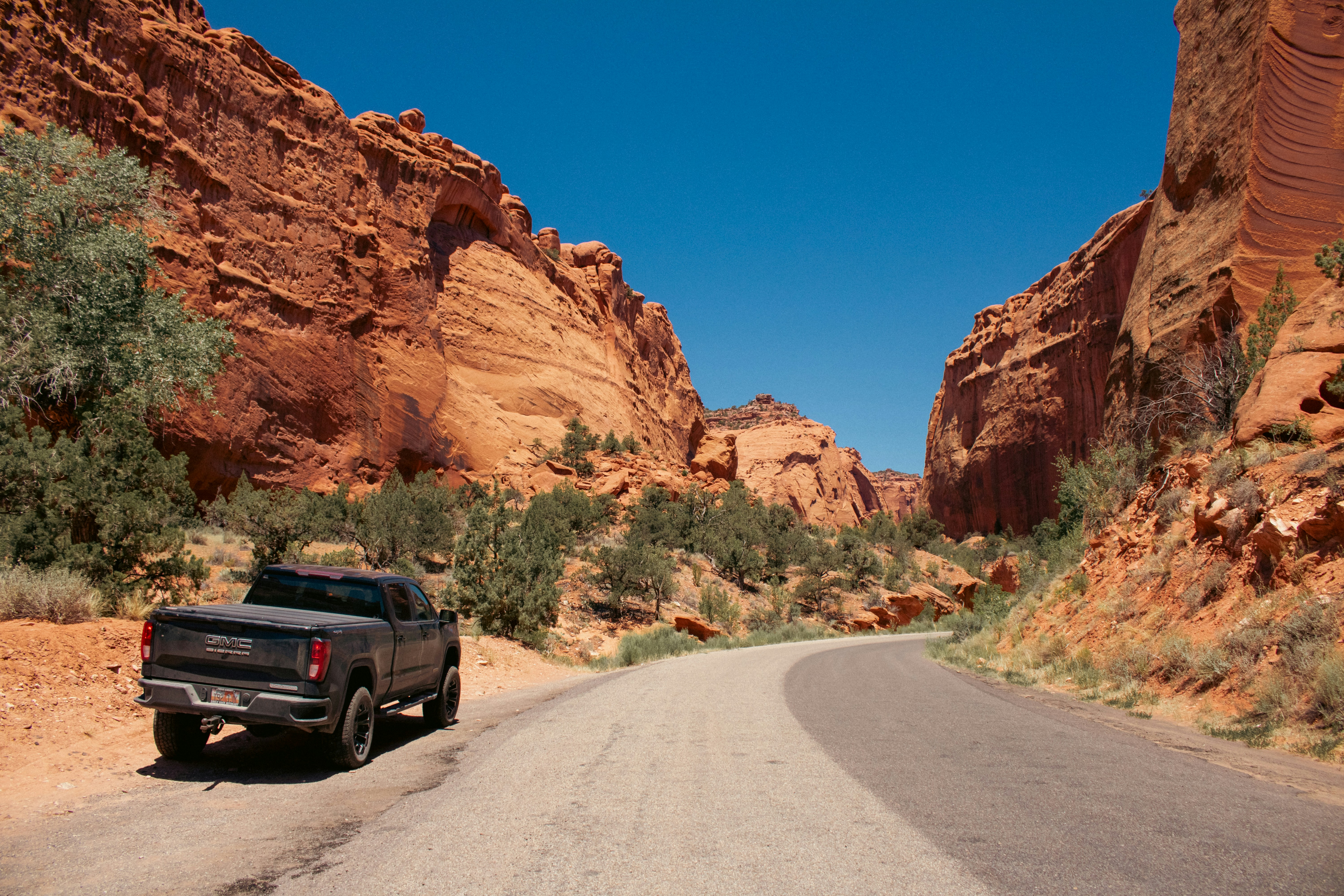 A GMC Truck is parked on the side of the Burr Trail road outside the Signing Canyon in Grand Staircase Escalante National Monument. It is a very scenic drive that continues on into Capitol Reef Park and Glen Canyon.