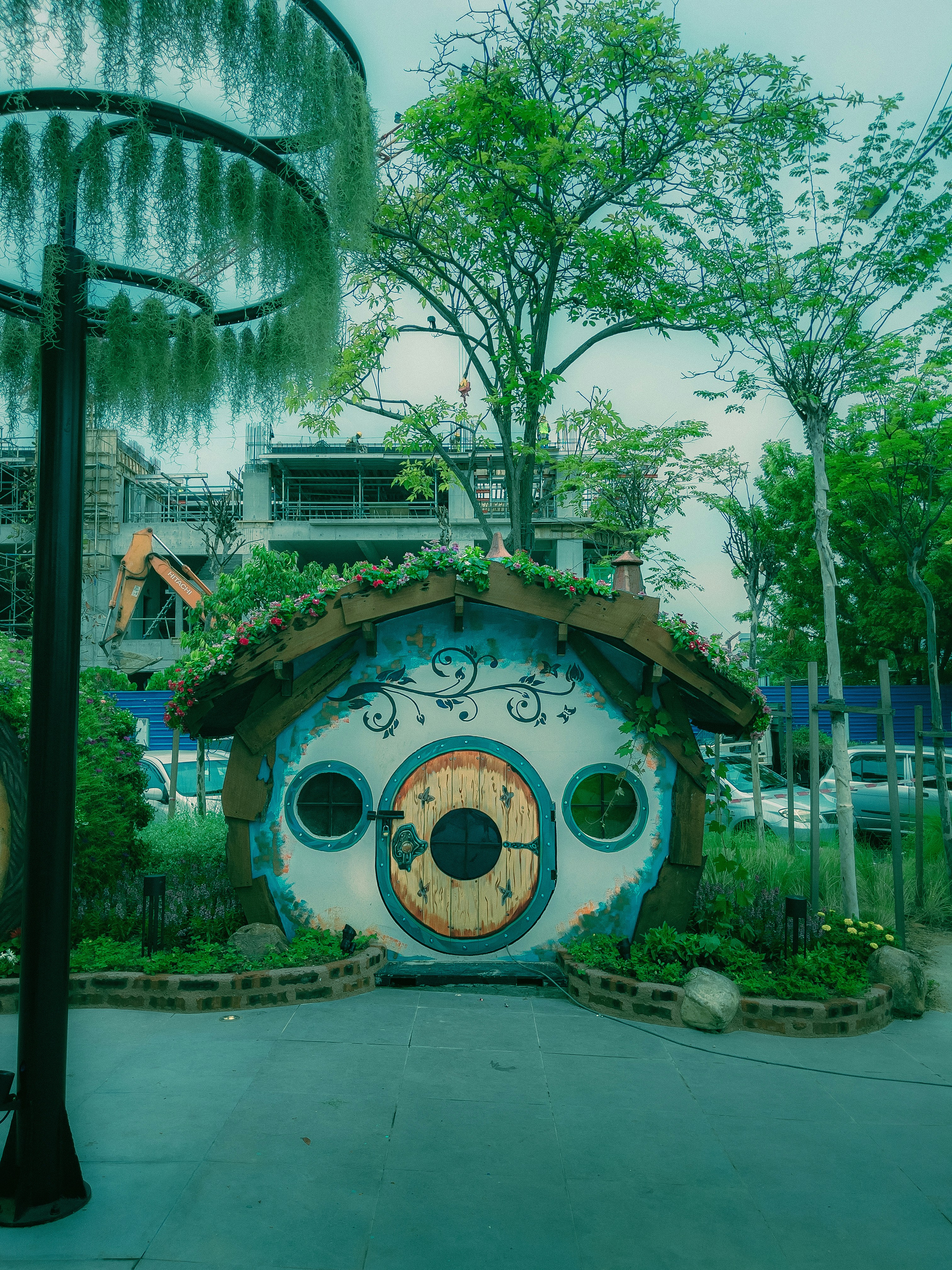 Whimsical Hobbit Door in a Leafy Park Courtyard