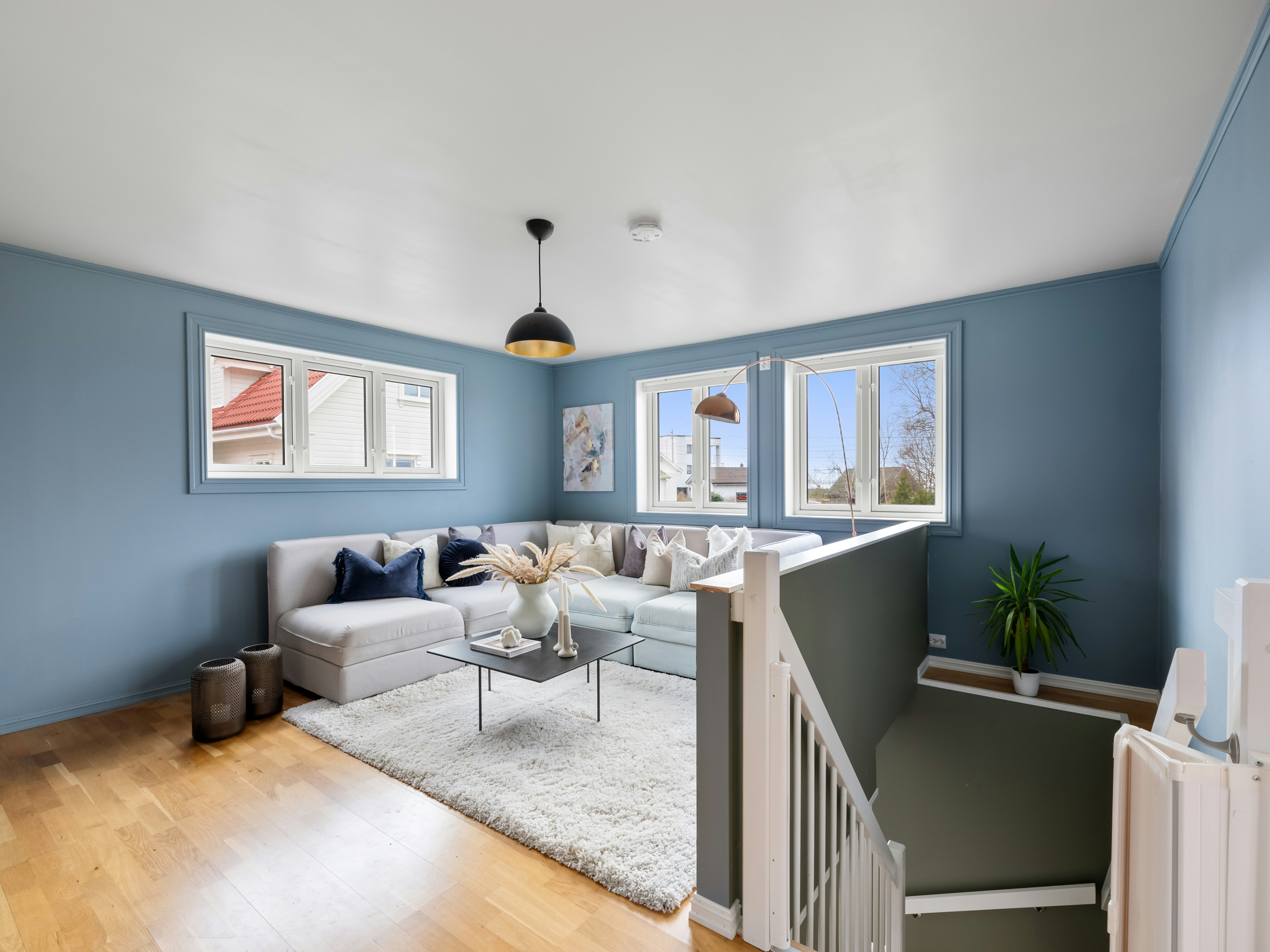 A living room with blue walls and hardwood floors photo – Free Home ...