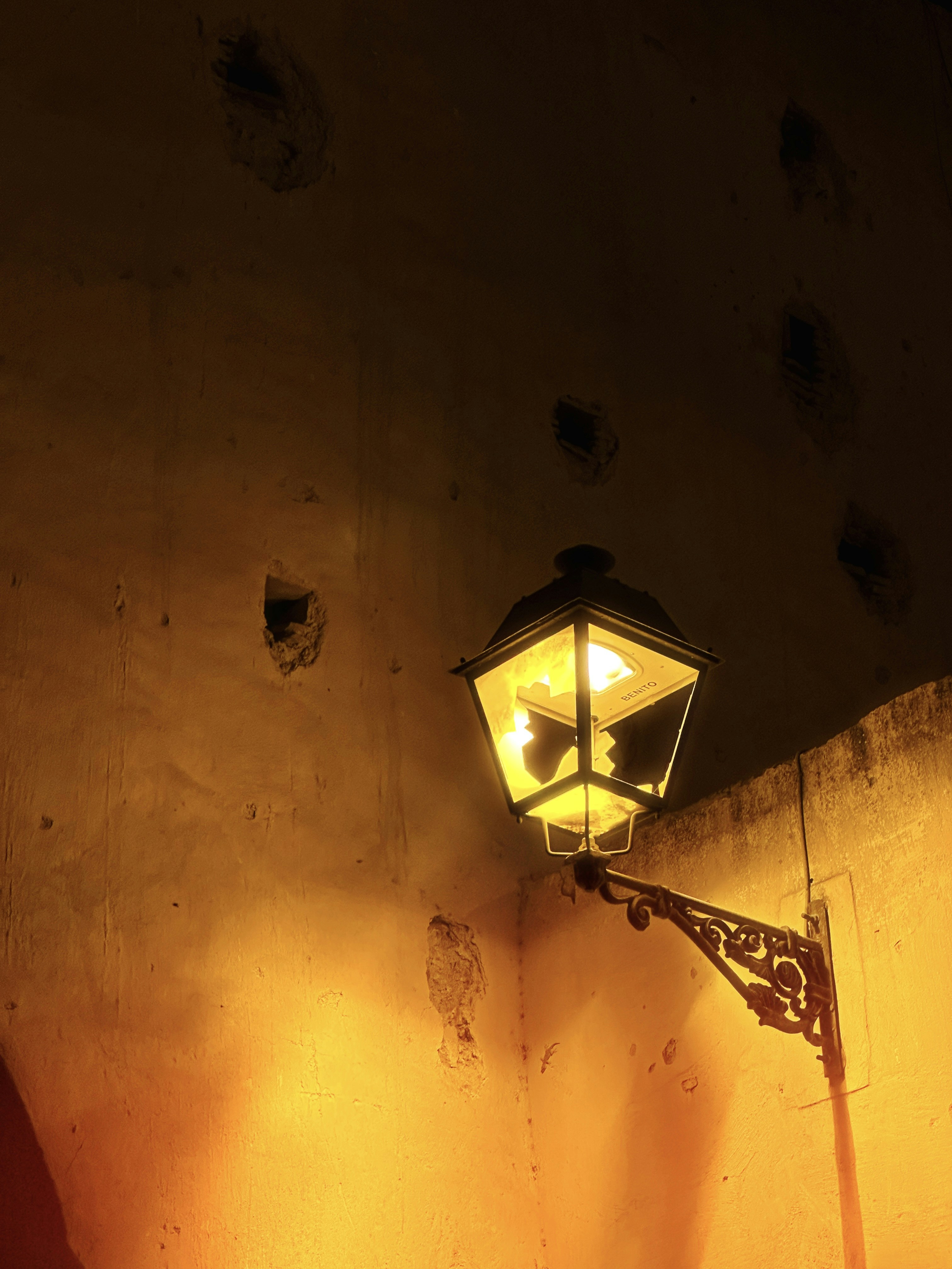A street light on the side of a building photo – Free Morocco Image on ...
