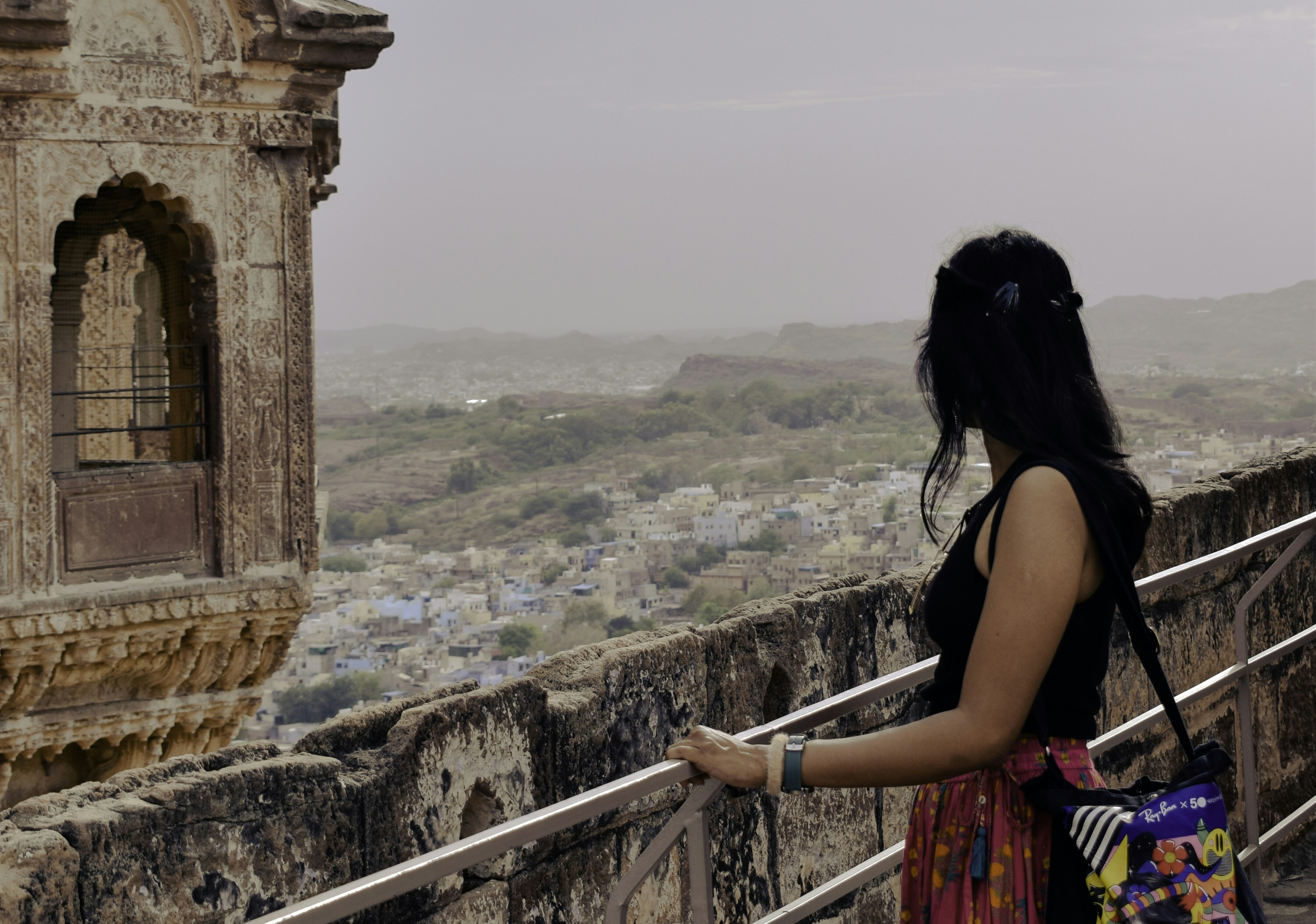 Amber Bastion Overlook: A Traveler Gazes Across a Valley from a Weathered Balustrade