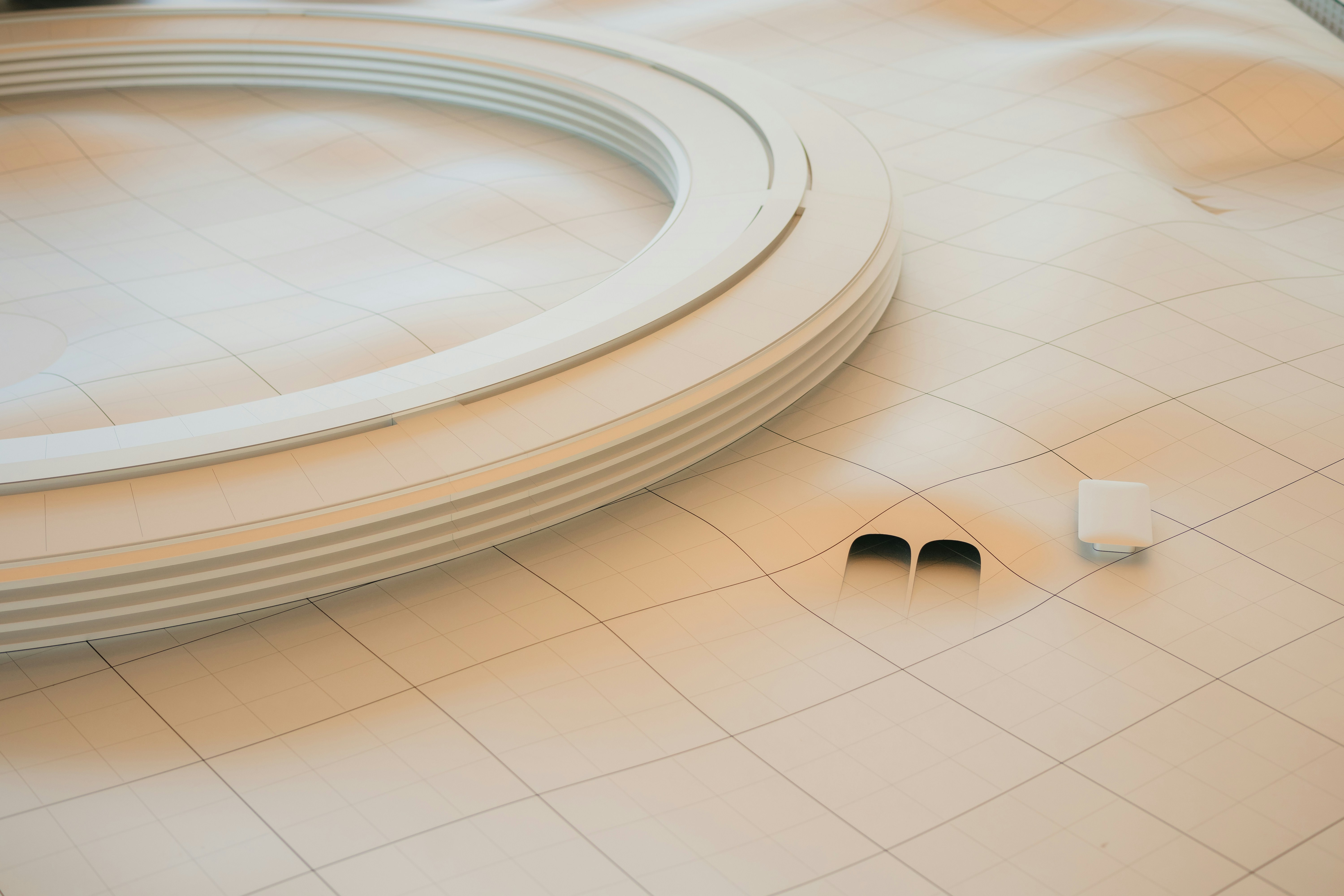 Quiet Geometry: A Circular Ring with Shadowed Arches on a Tiled Floor