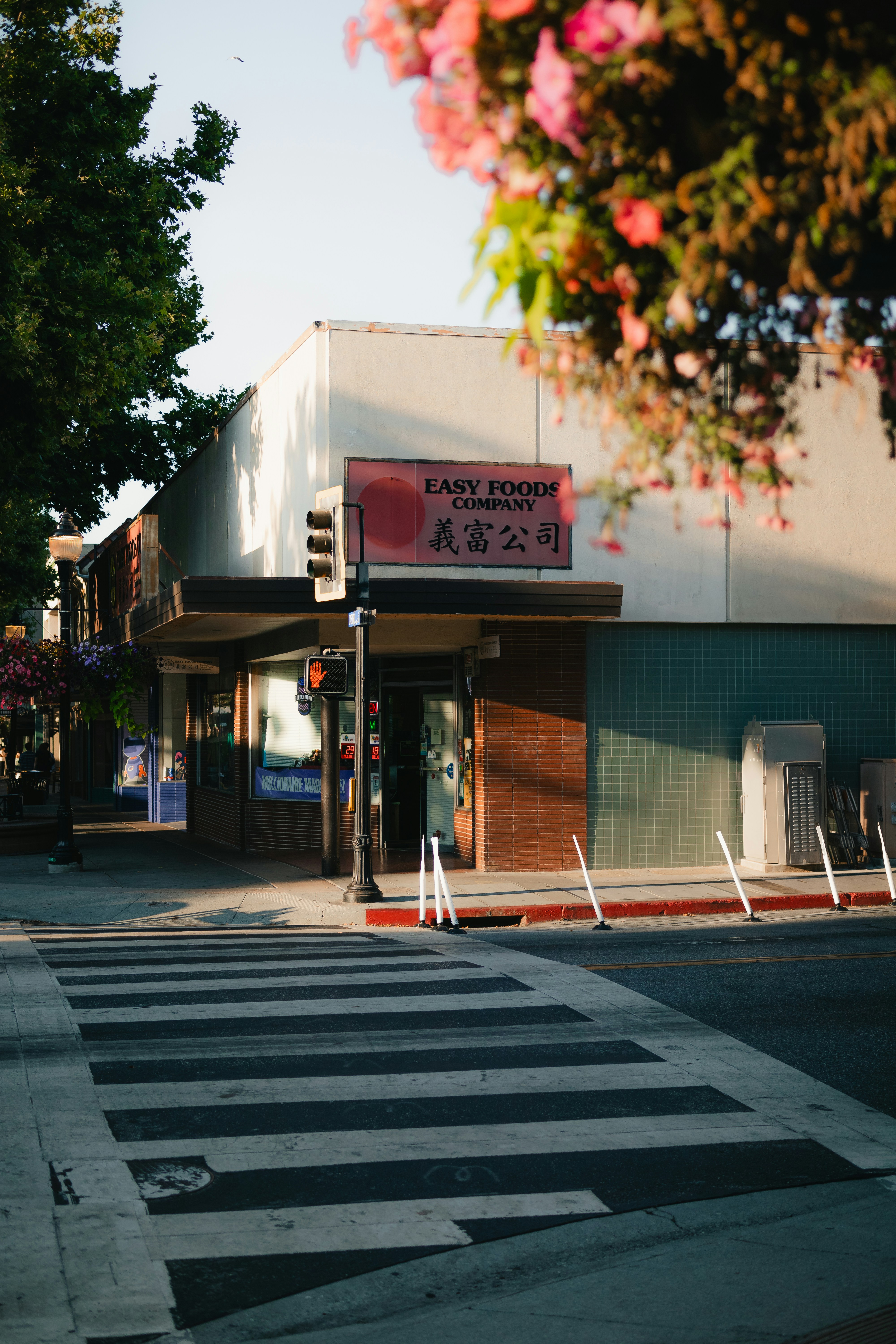 A street corner with a crosswalk and a store photo – Free Asphalt Image ...