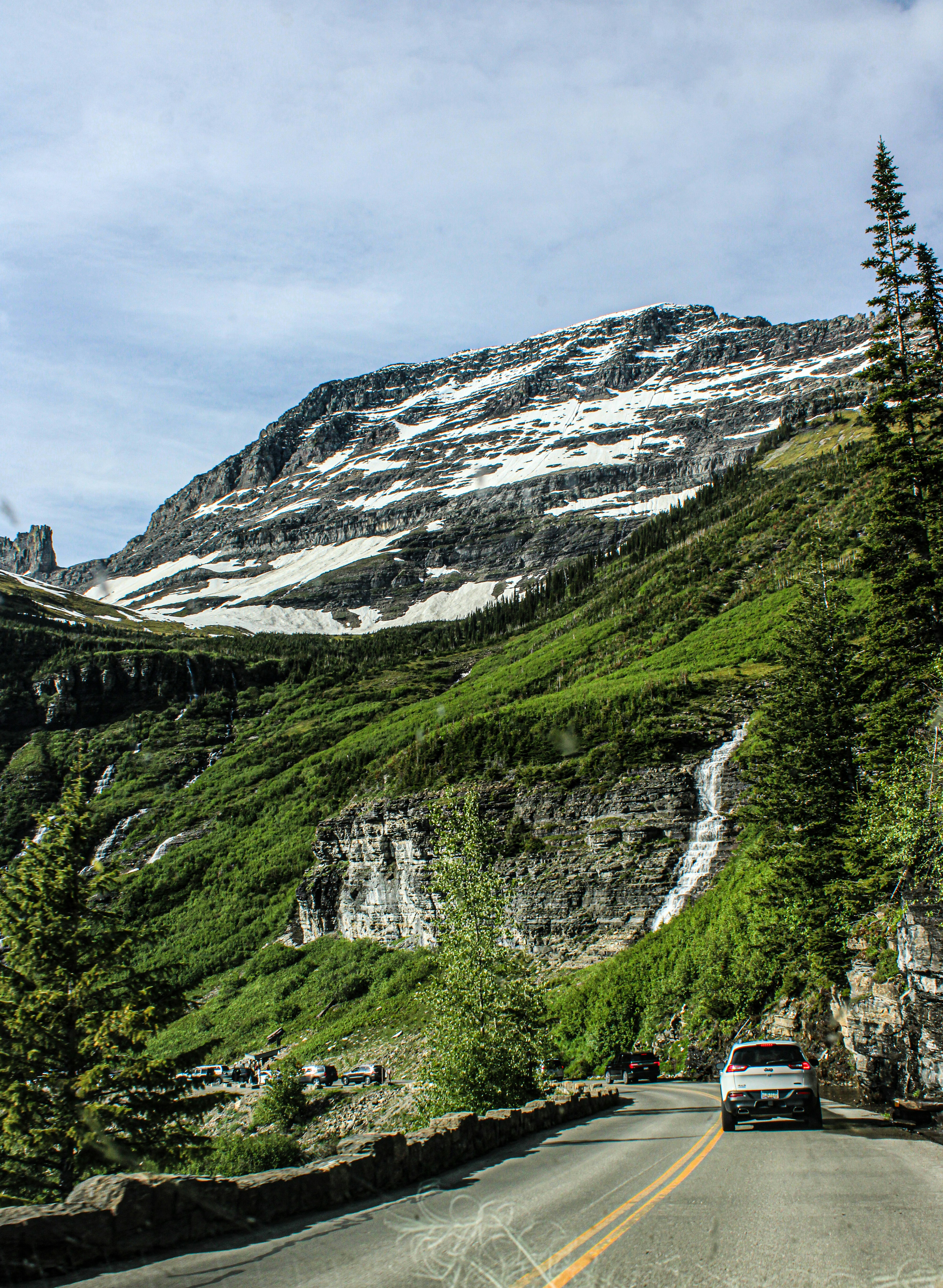 Winding Edge: A Mountain Pass Unfolding Beneath Snowy Peaks