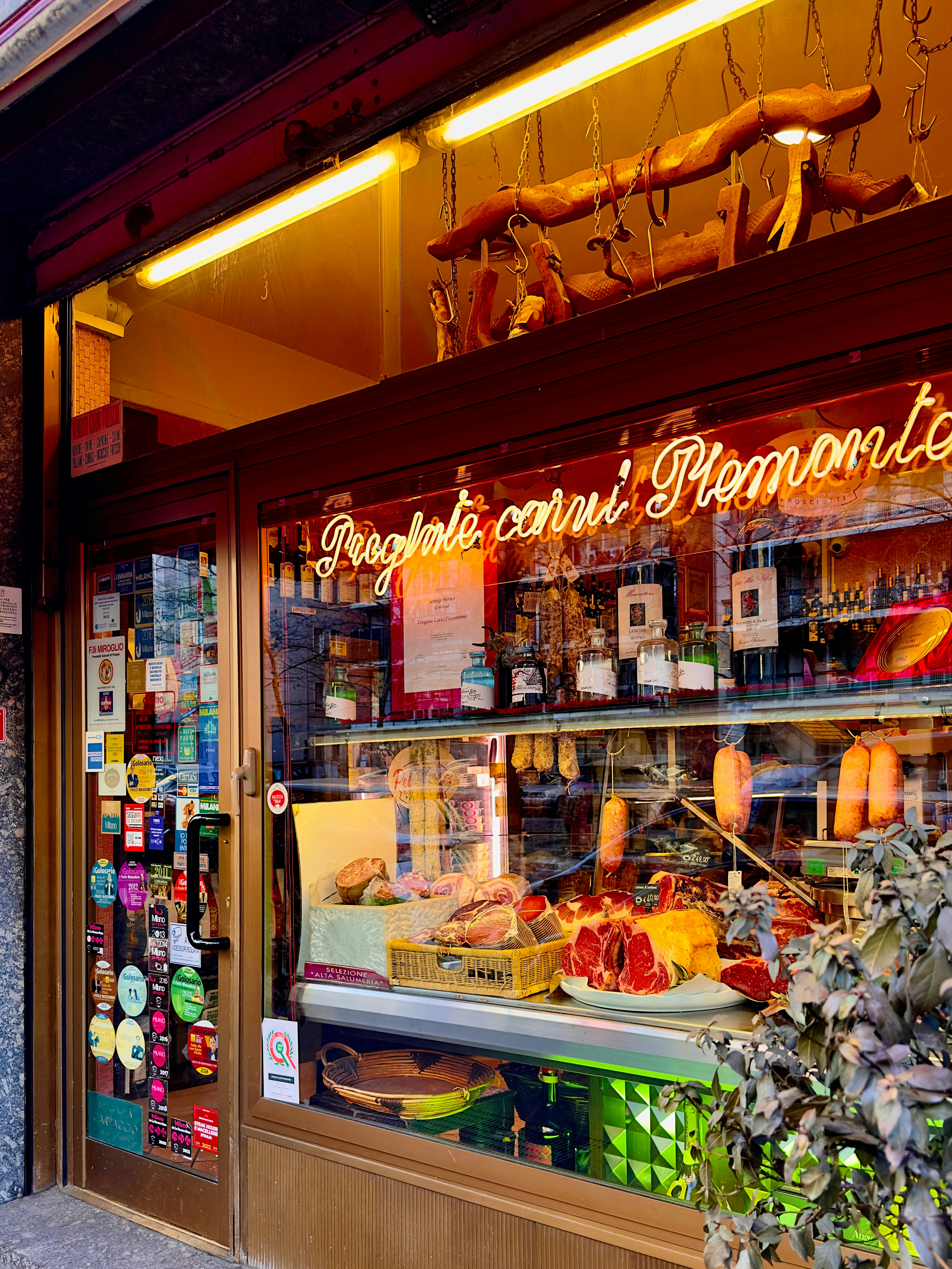 Neon Glow Over a Deli Window Brimming with Cured Meats