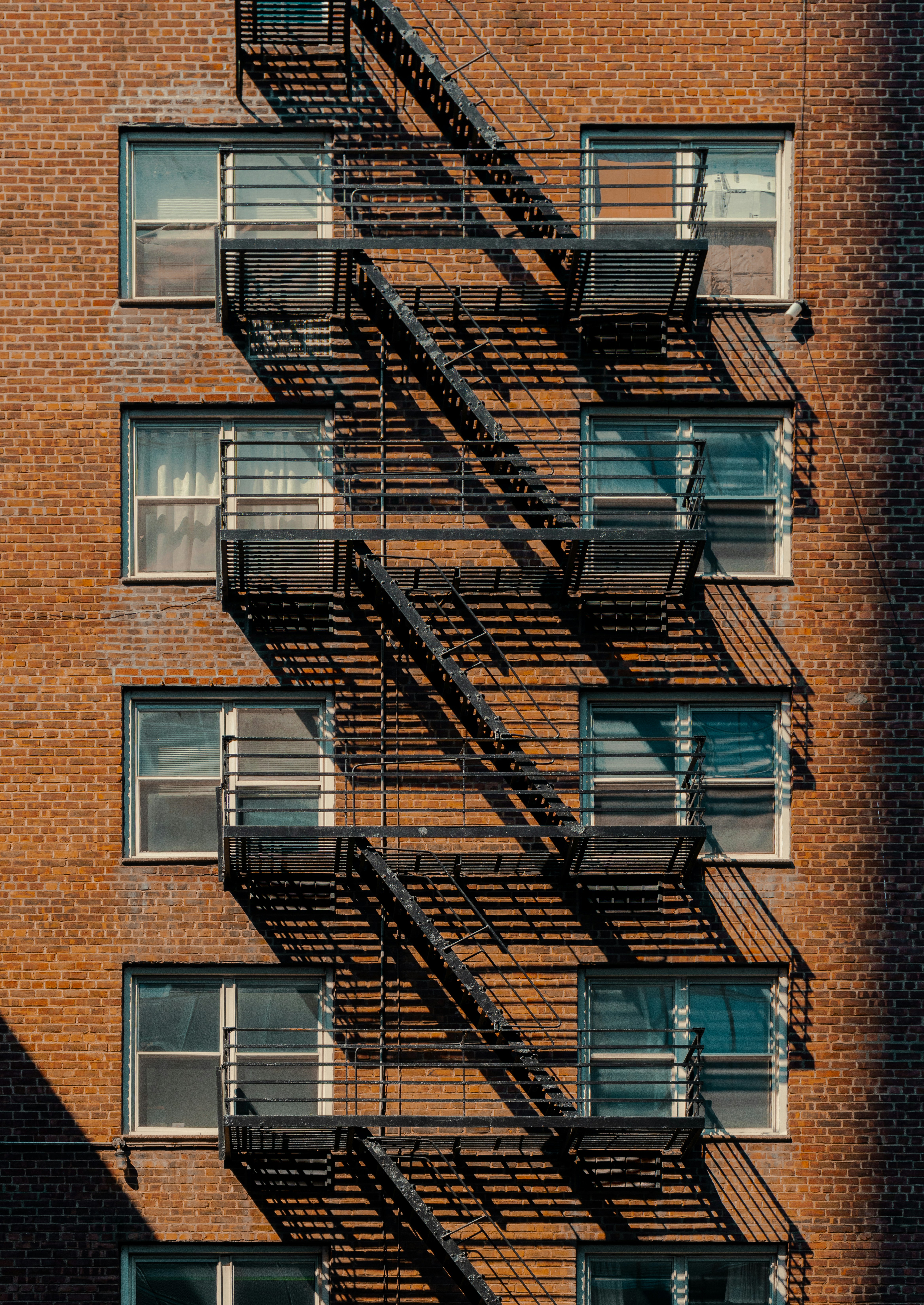A fire escape on the side of a brick building photo – Free New york ...