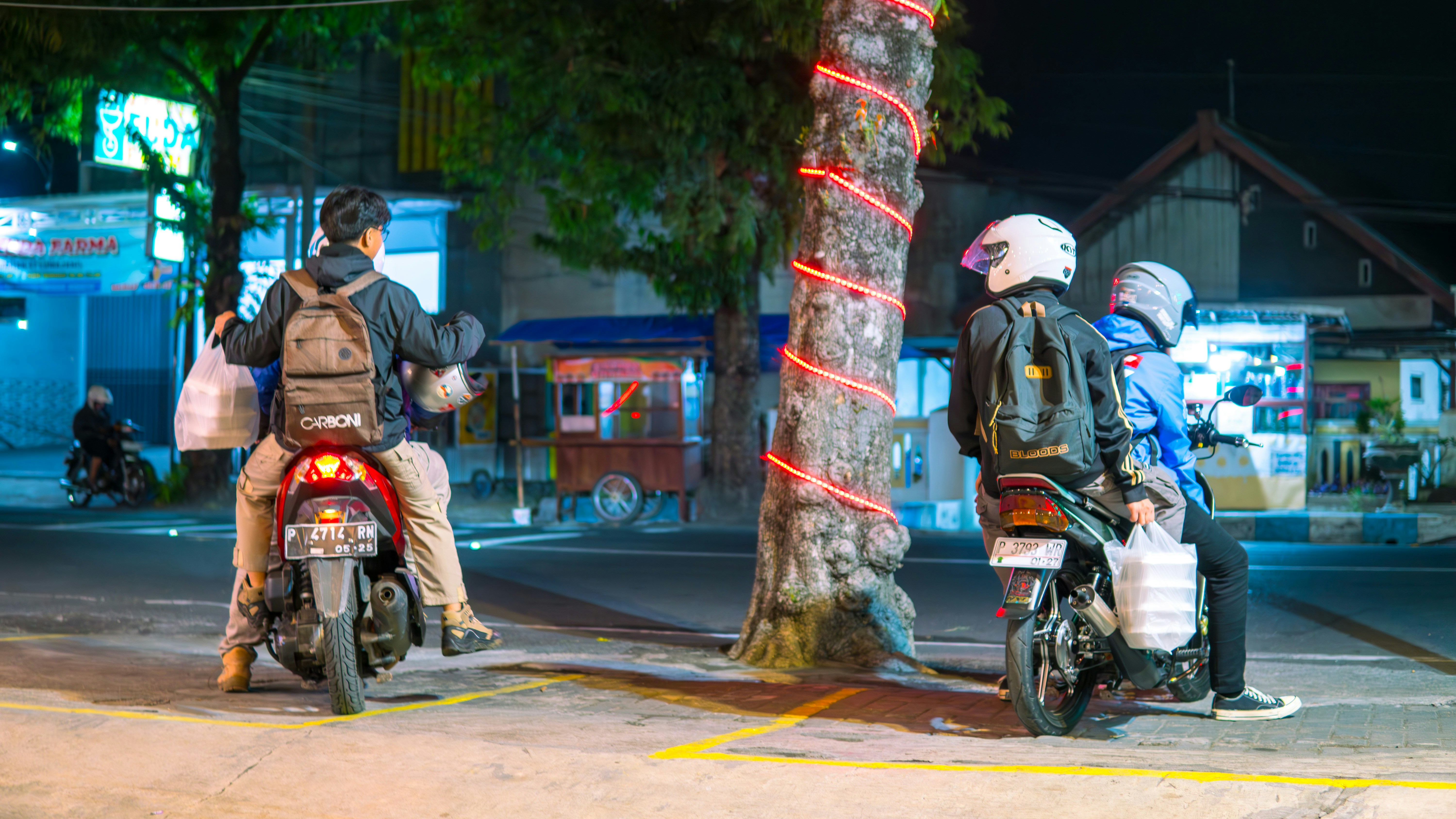 A group of people riding motorcycles down a street photo – Free Man ...