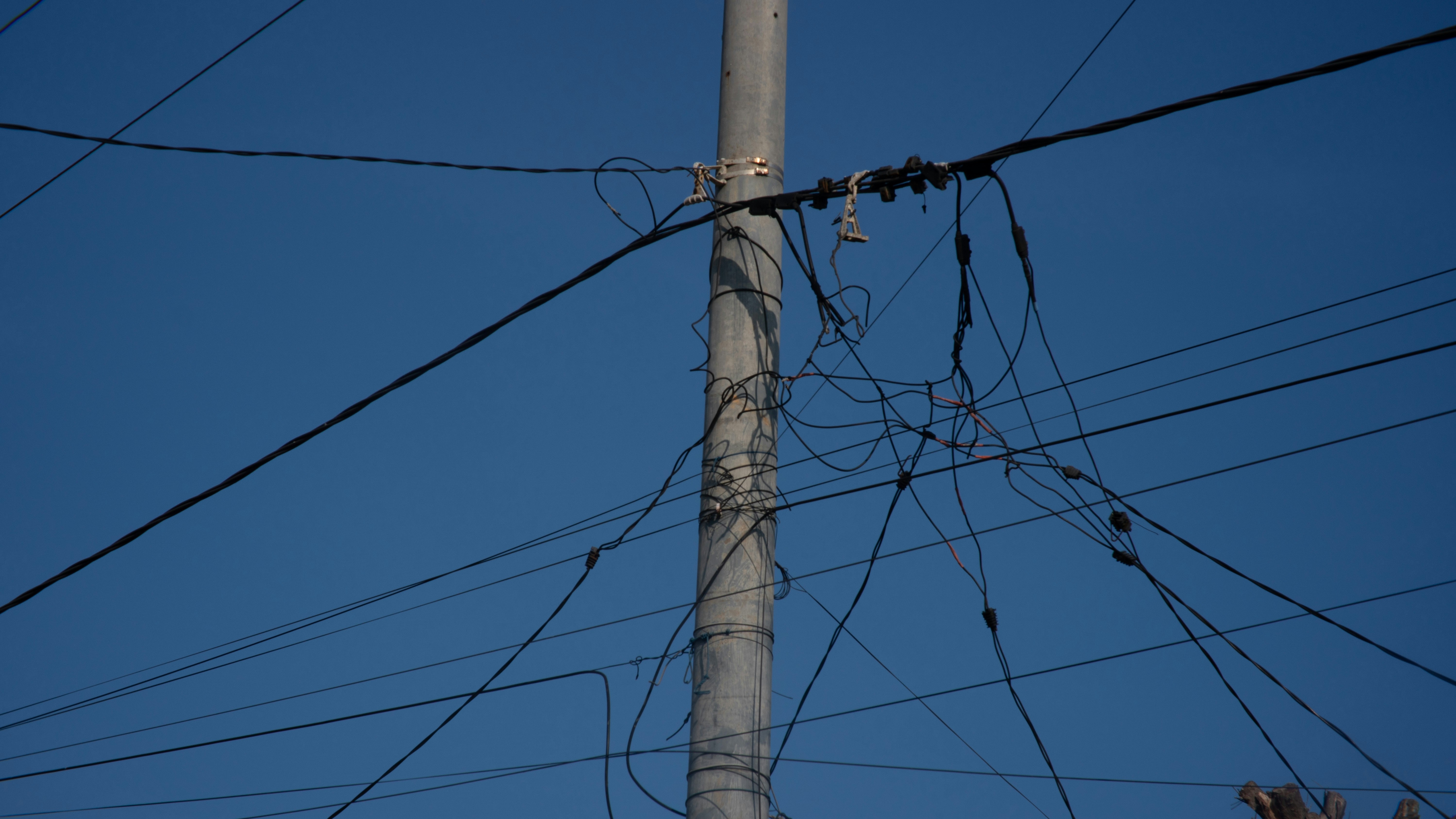 A street sign on a pole with power lines in the background photo – Free ...