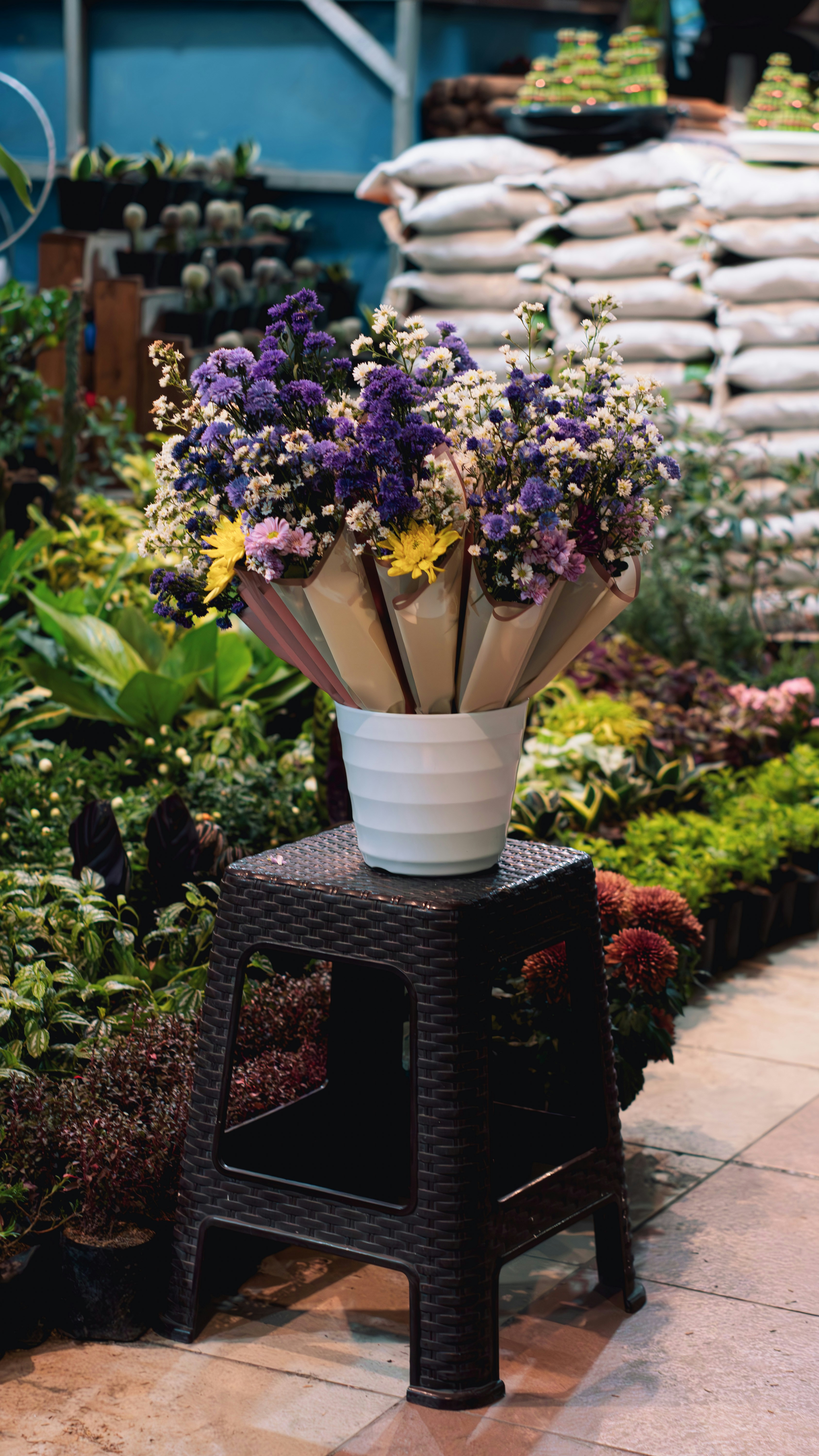 Bouquet on a Stool: Vibrant Florals in a Garden-Center Display