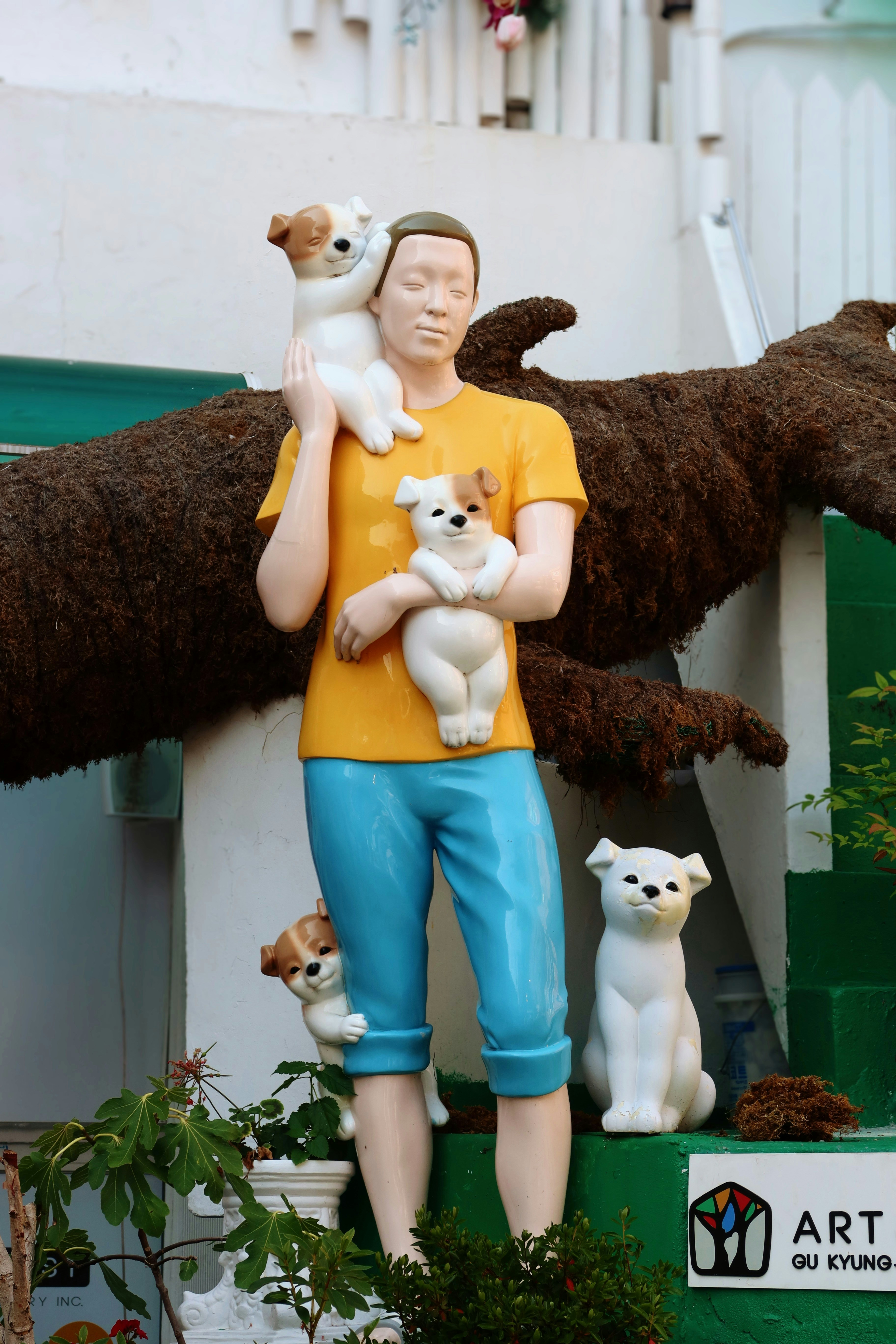 Sunny Orange Shirt Ceramic Statue: A Father with Puppies in a Garden Art Scene