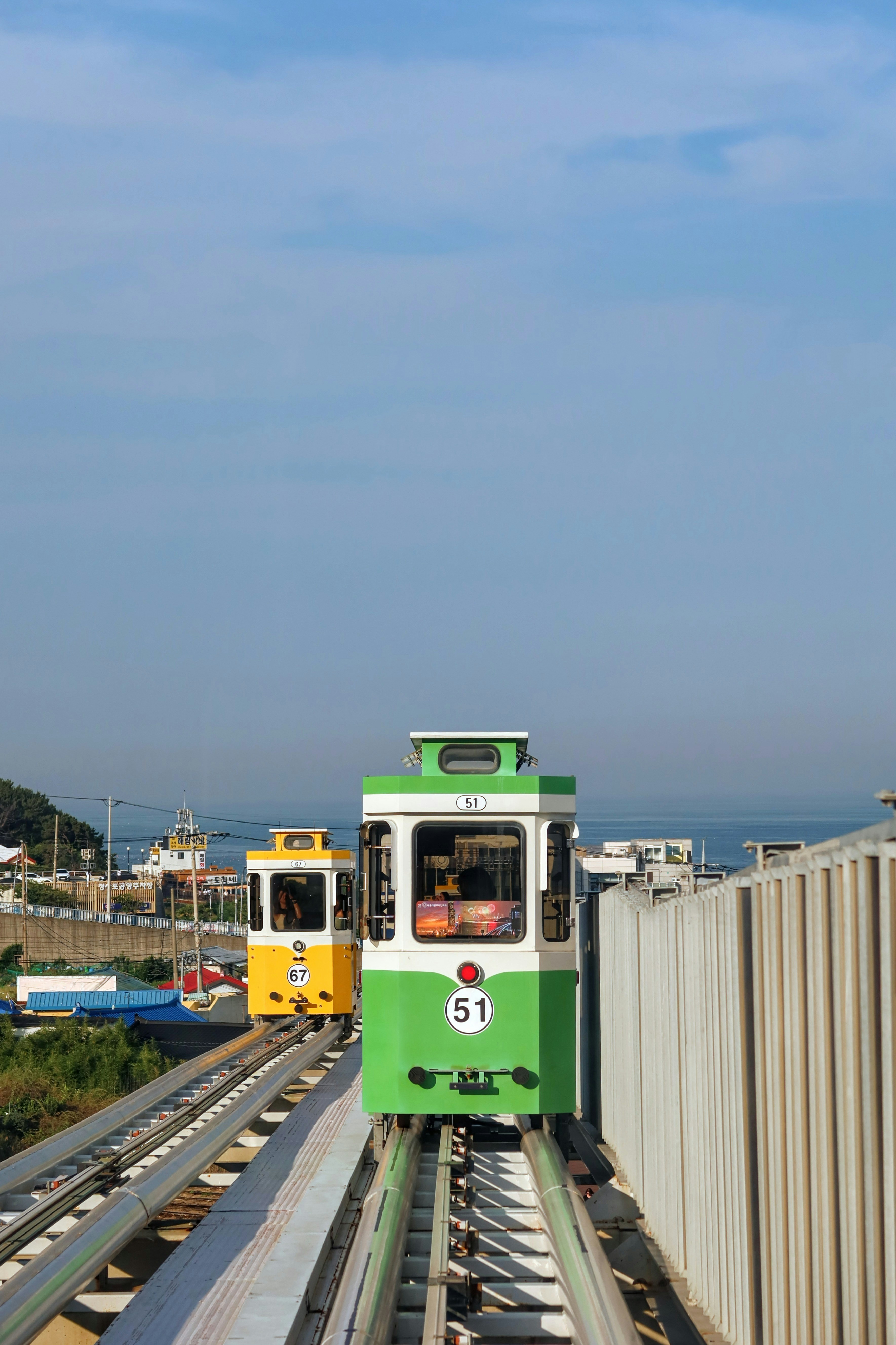 A green and white train traveling down train tracks photo – Free Busan ...