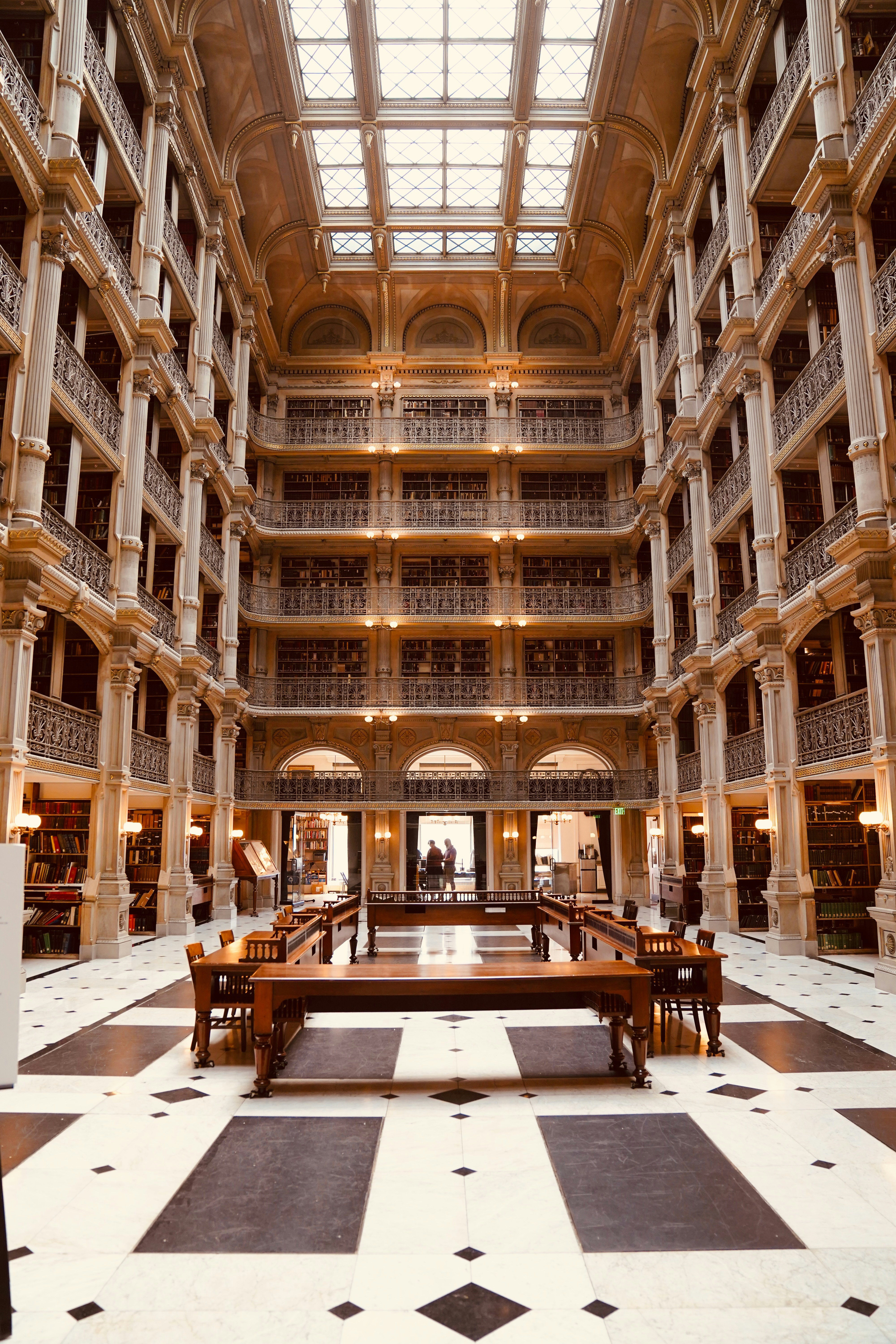 A large library with a checkered floor and a skylight photo – Free ...