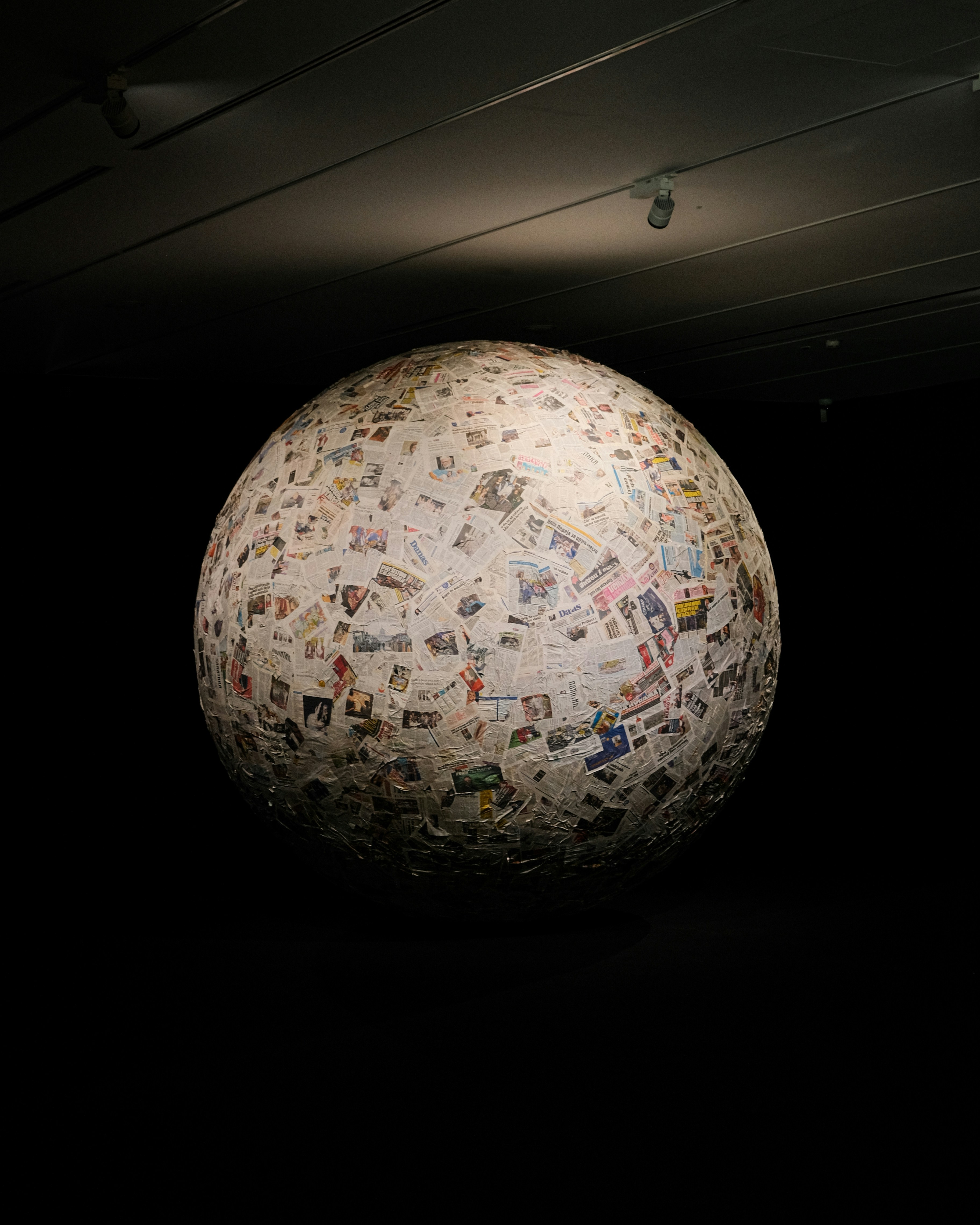 Orb of Headlines: A Night-Gallery Globe Woven from Newspapers