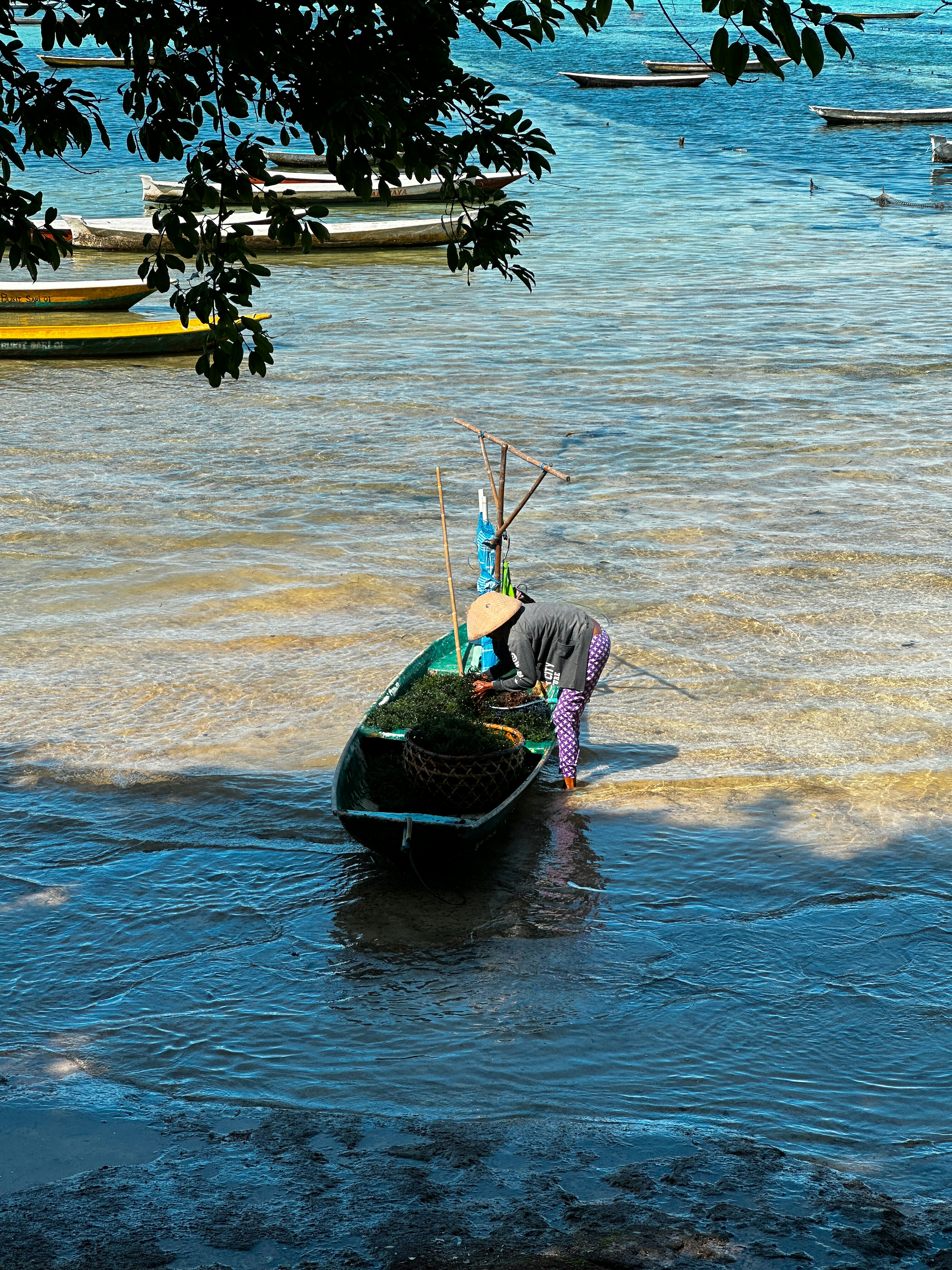 Green Boat, Quiet Labor on a Turquoise Shore