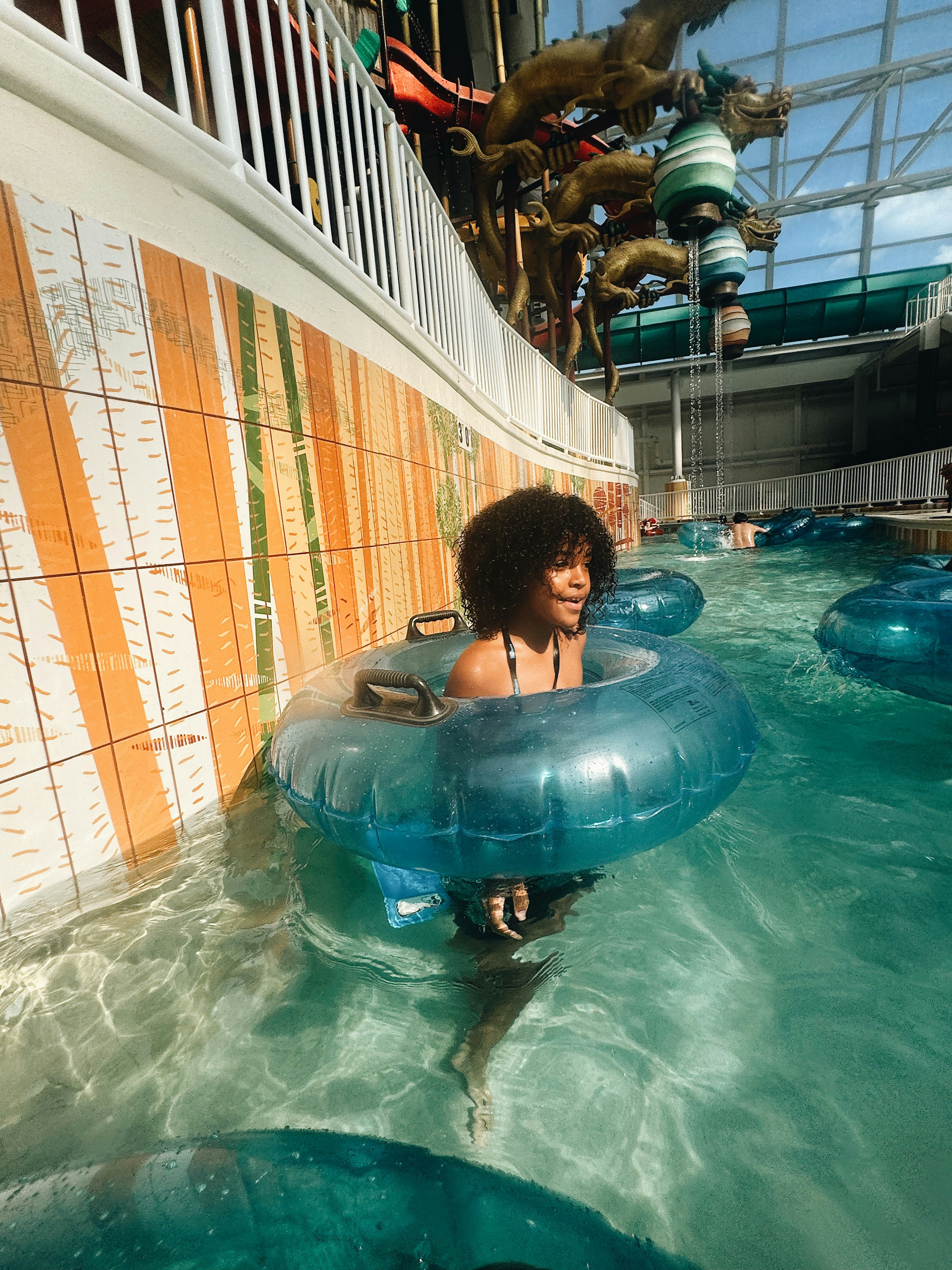 A woman riding a tube down a water slide photo – Free American dream ...