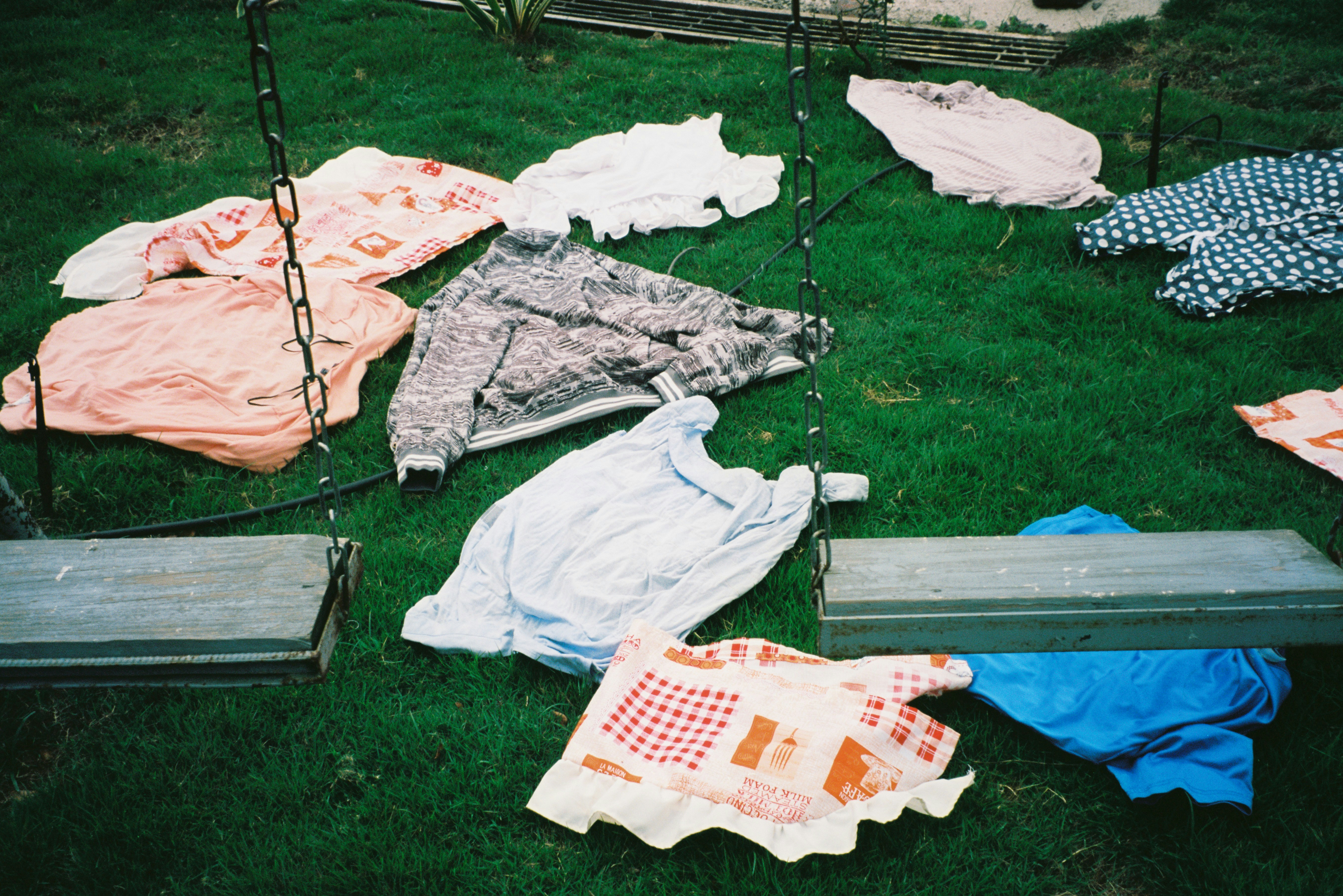 A bunch of clothes that are laying on the ground photo – Free Constanza ...
