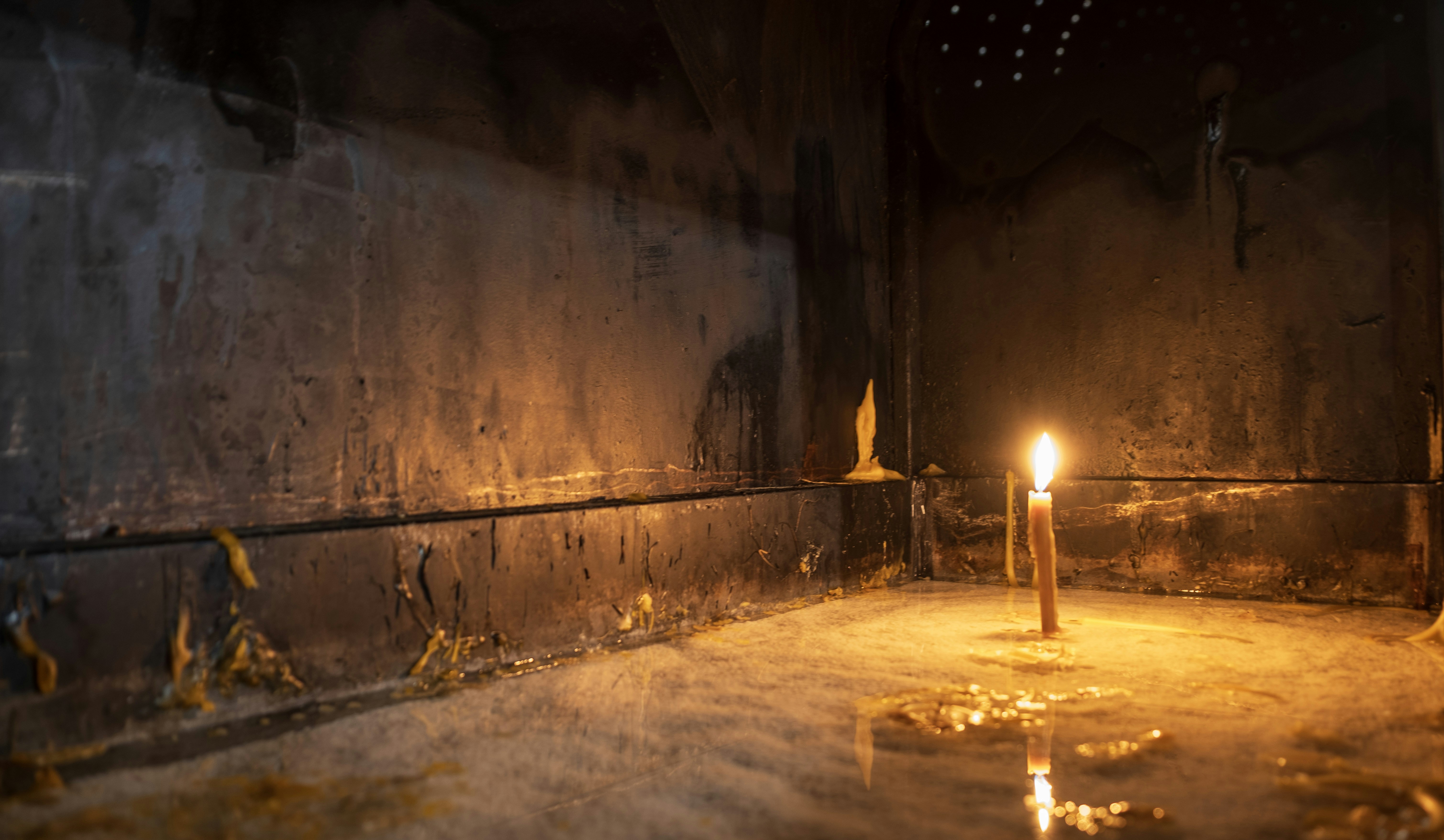 Solitary Flame in a Shadowed SanctuaryDennis Thompson