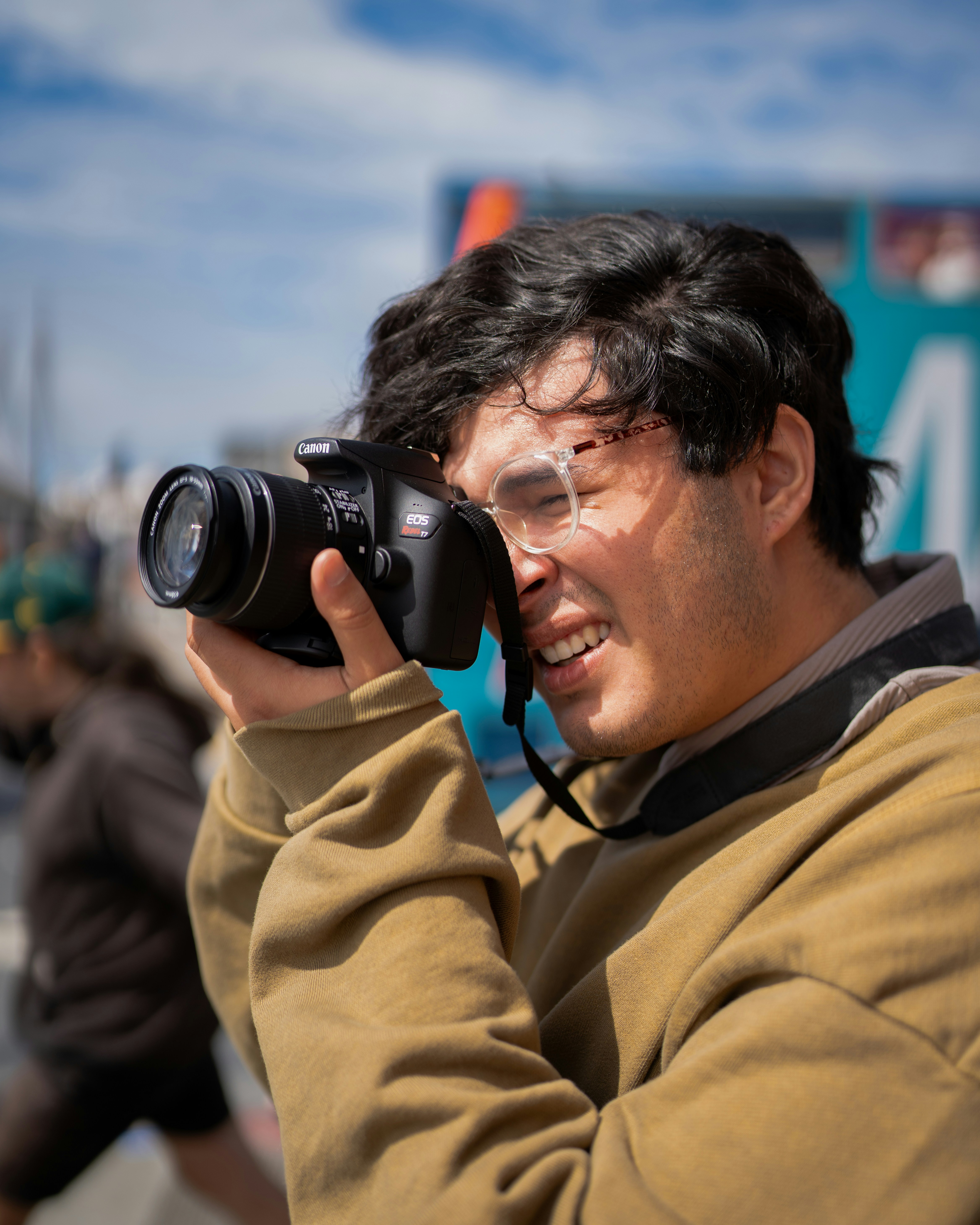 Focus in the Crowd: A photographer mid-swing at an outdoor event