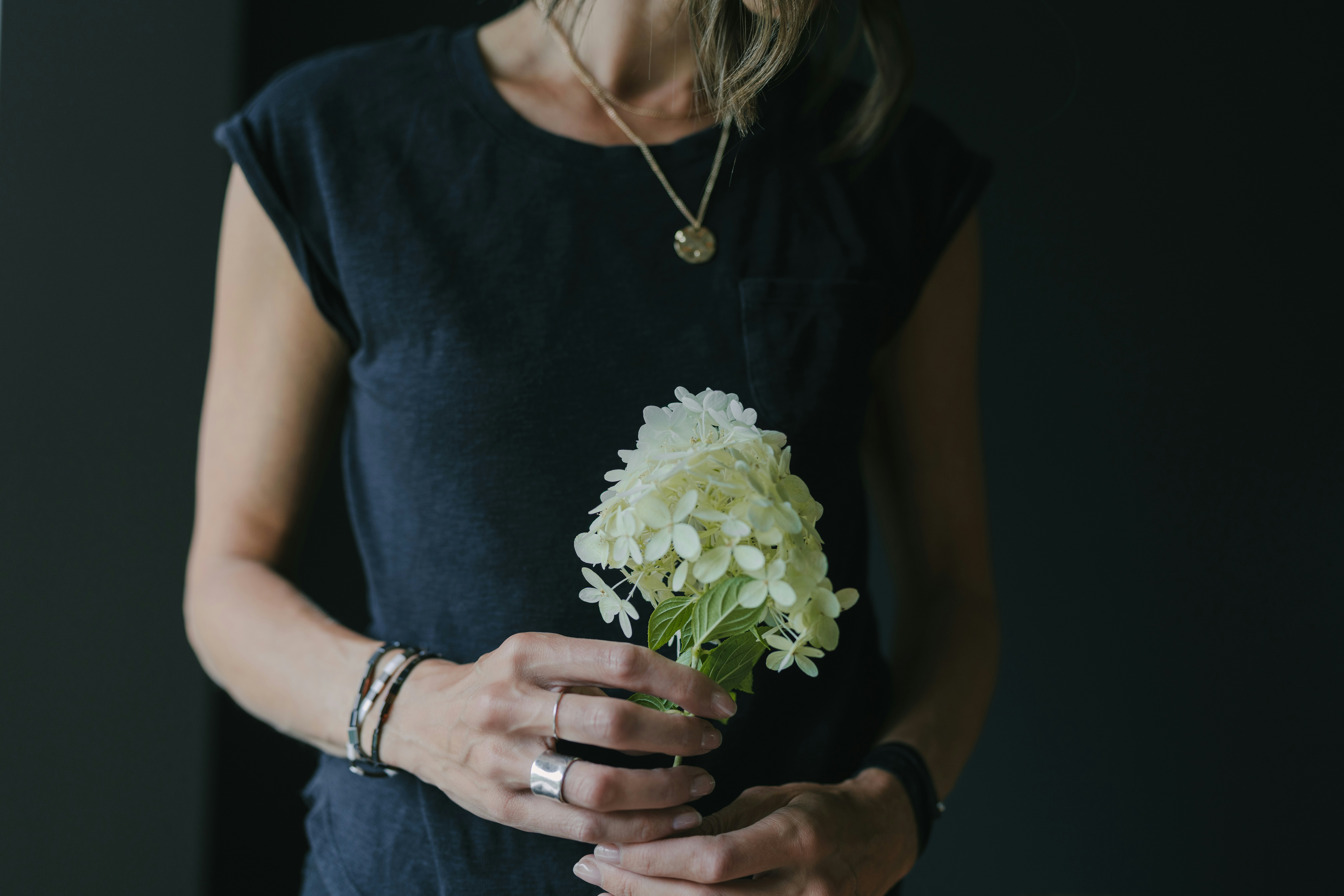 A woman holding a bouquet of flowers in her hands
