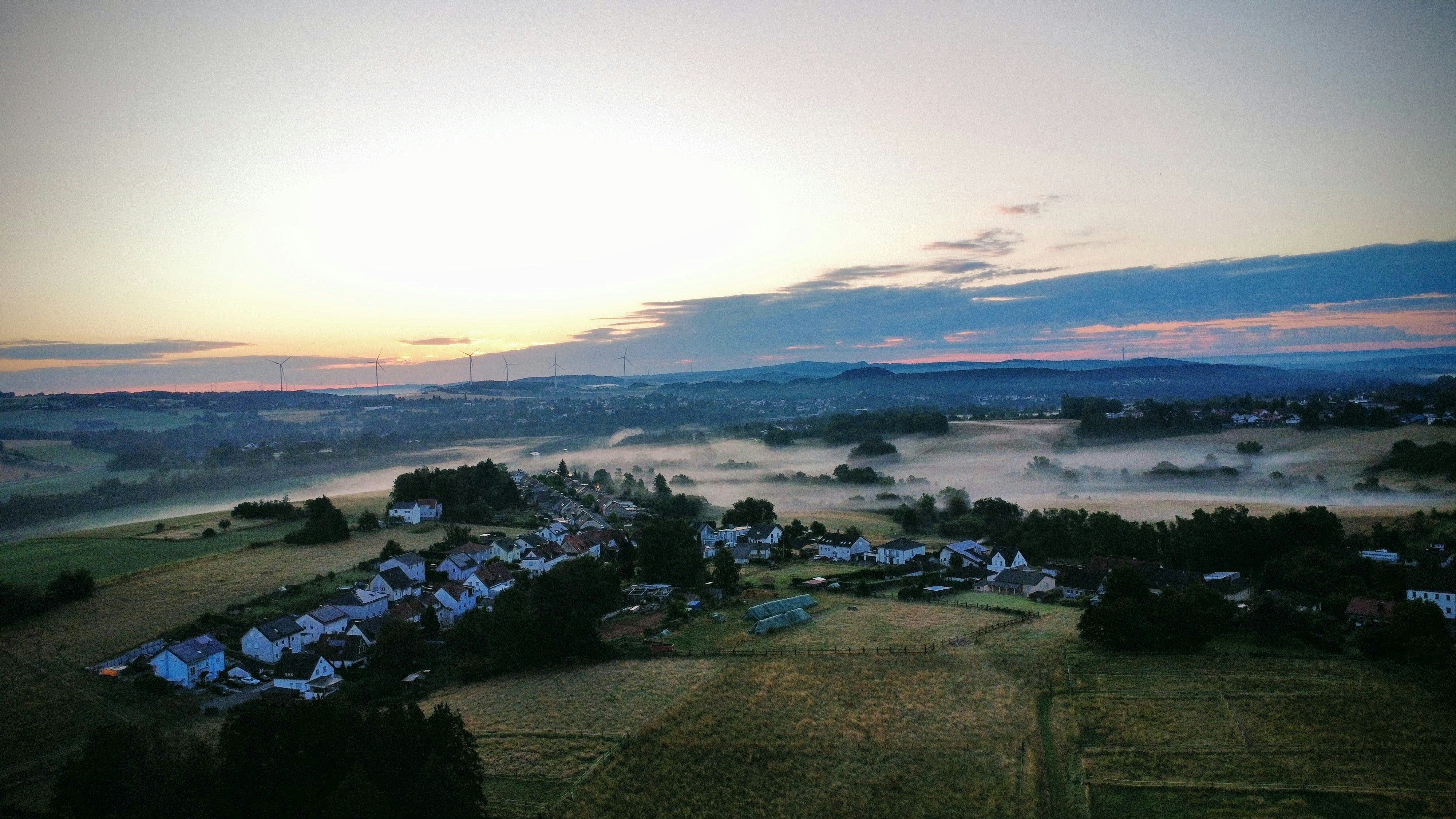 Dawn over a Misty Valley: A Quiet Village Emerges from the Fog