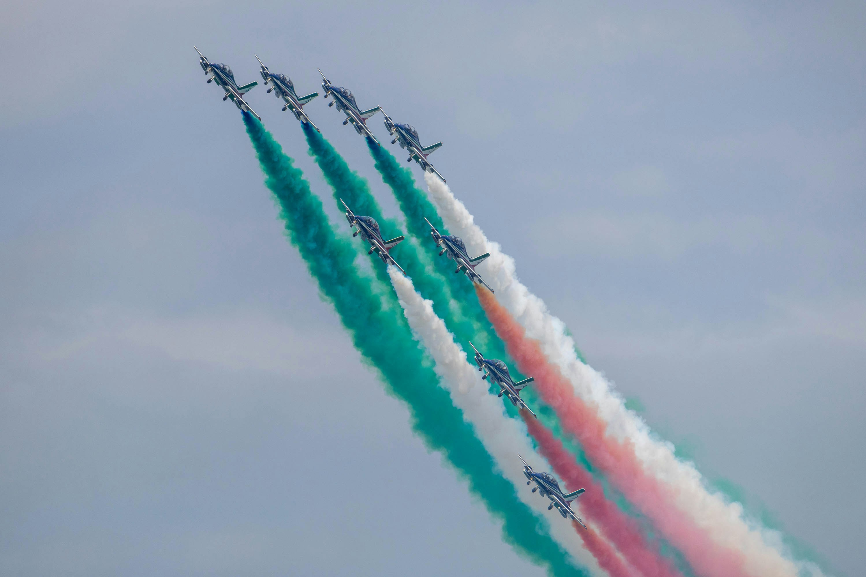 A group of jets flying through a blue sky photo – Free Italy Image on ...
