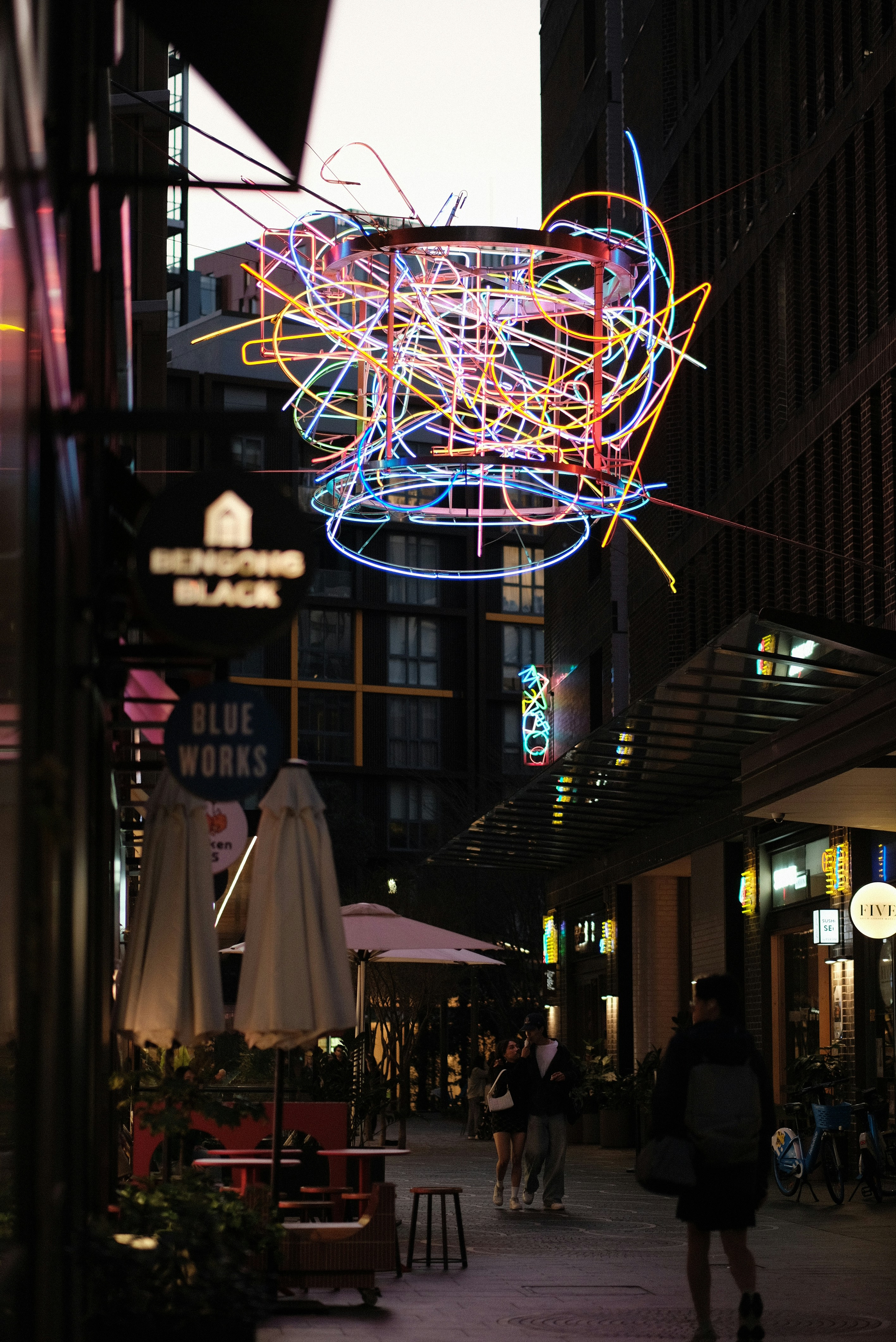Neon Scribbles Over a Narrow Night Alley