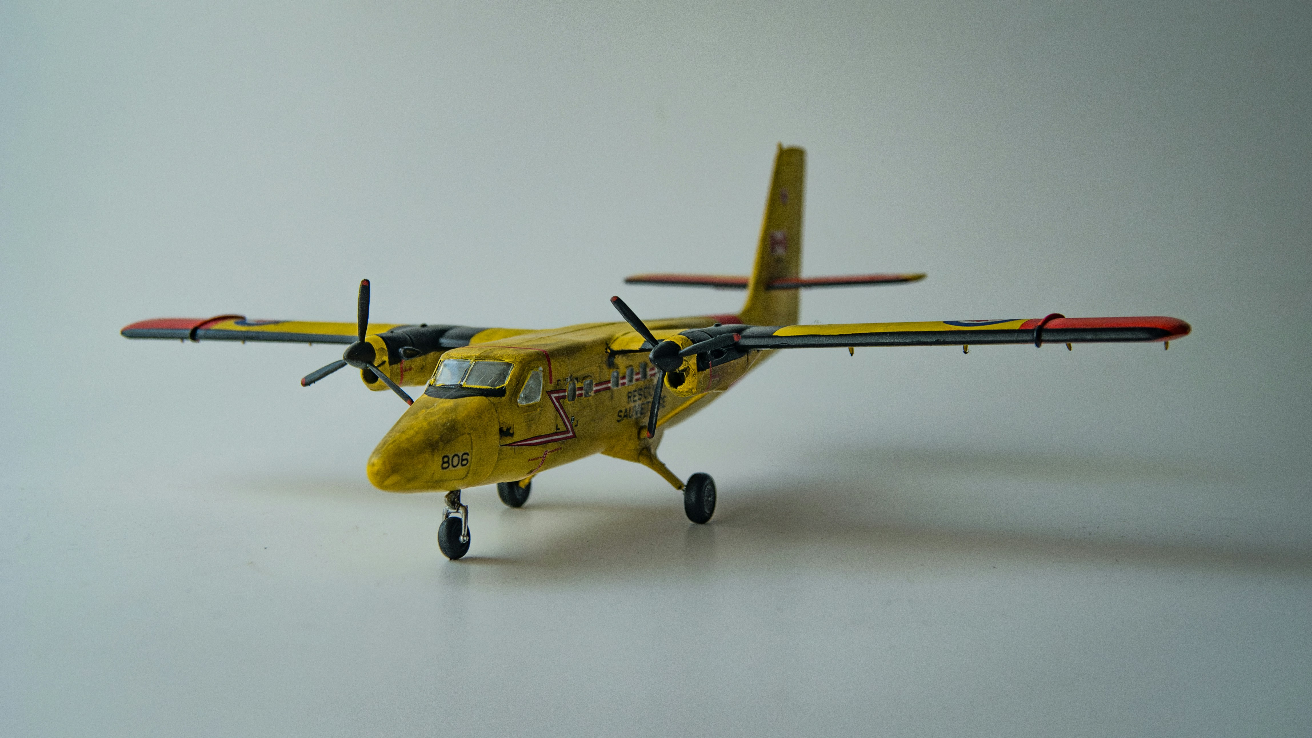 A small yellow airplane on a white surface photo – Free White ...