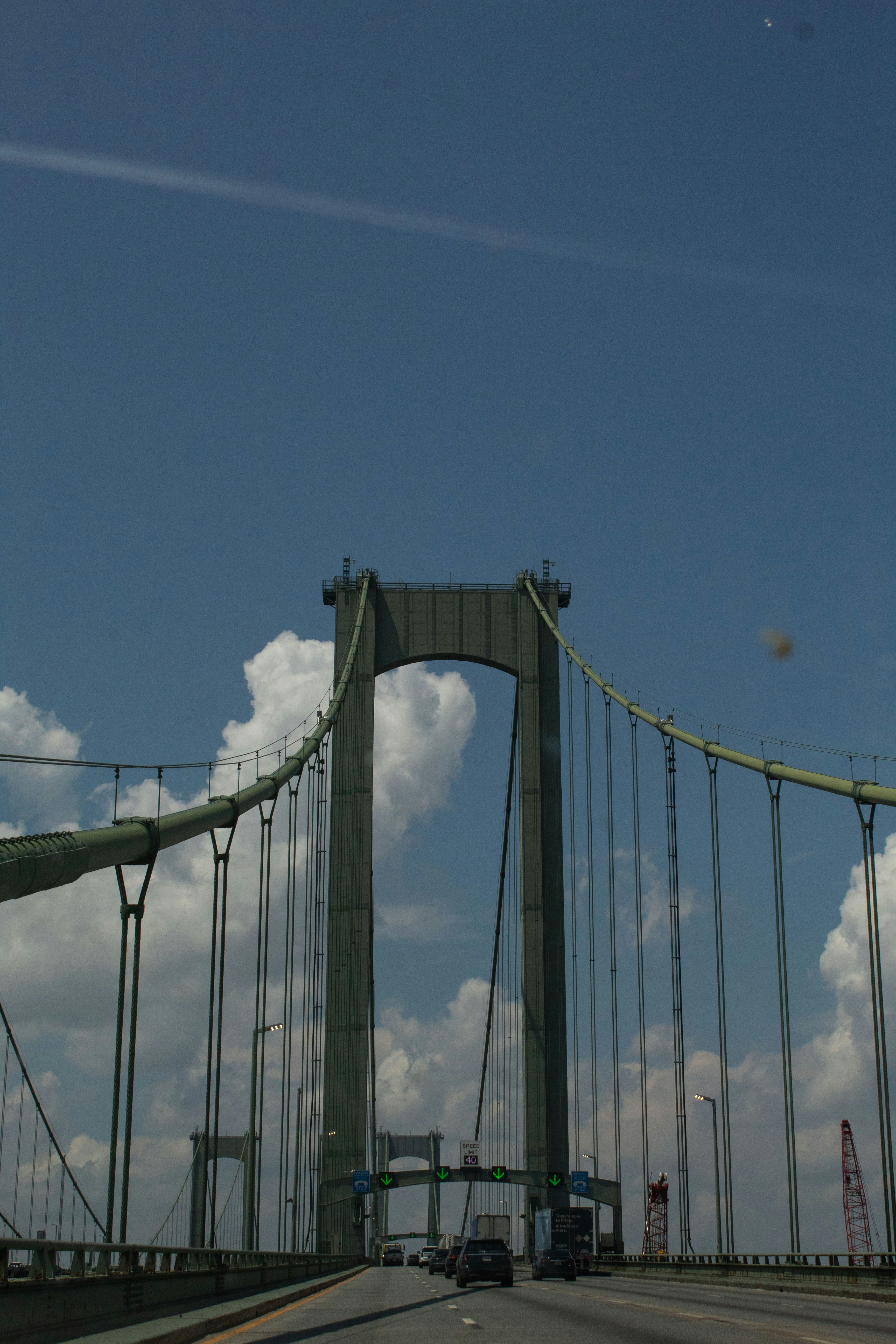 Spanned Lines: Central Tower and Cables of a Green Suspension Bridge under Cerulean Sky