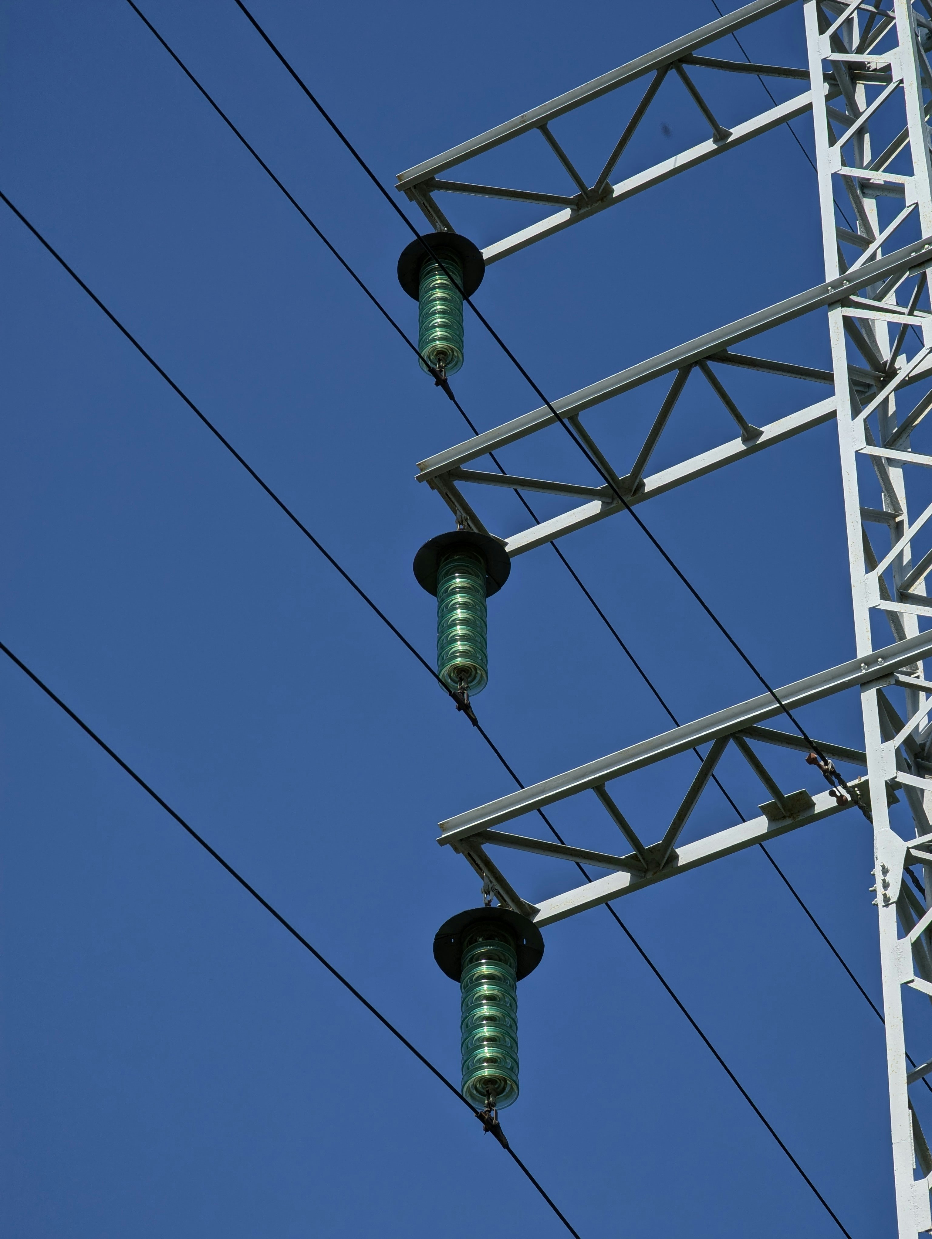 Green Glass Insulators Align Along a Steel Lattice Under a Pristine Sky
