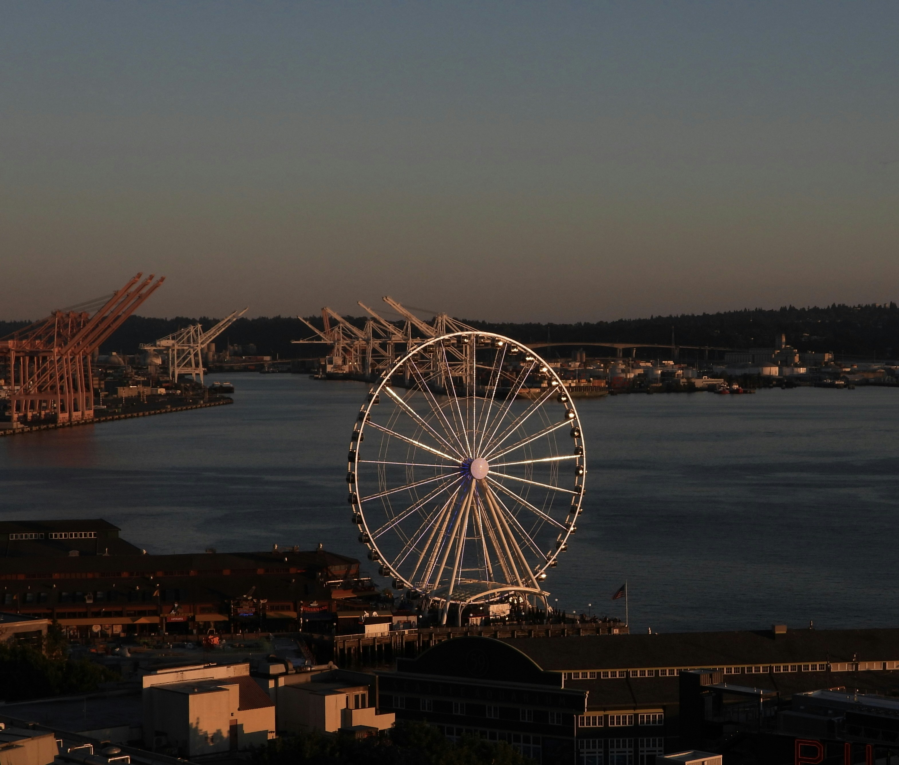 Dusk on the Waterfront: The Ferris Wheel Framing the Harbor Cranes