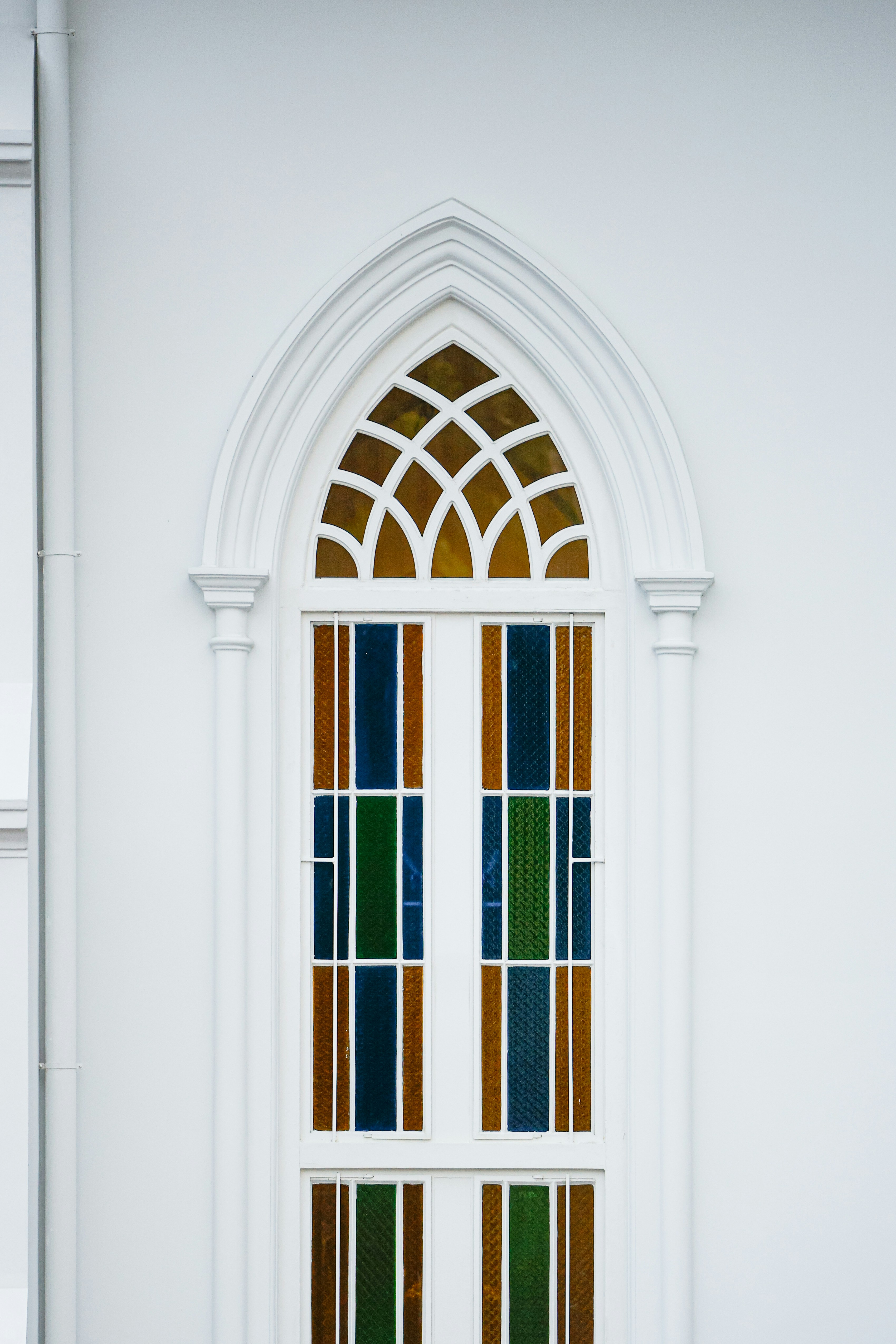 A white wall with a stained glass window