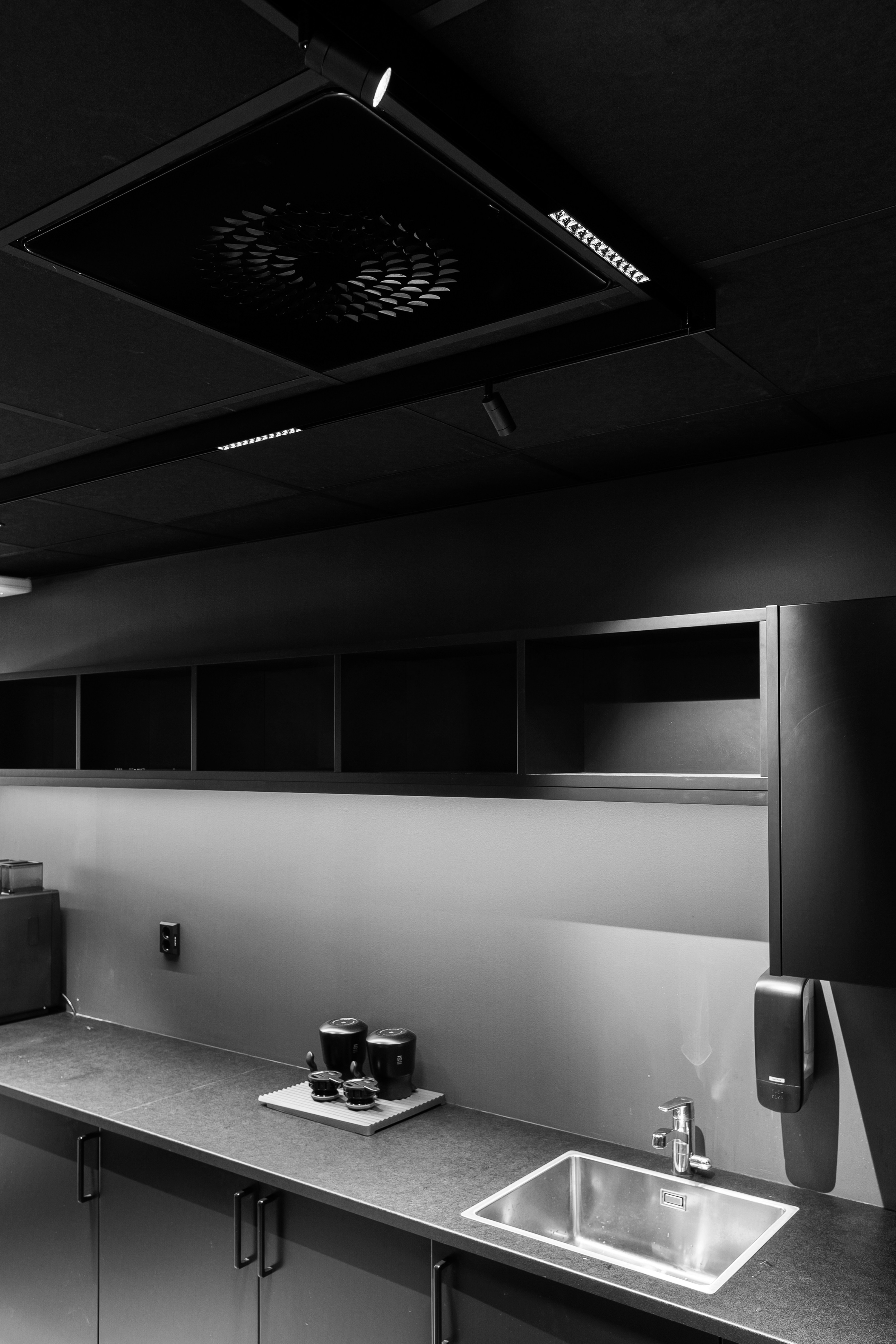 Monochrome Workbench: Cup Tray Amid Minimalist Kitchen Studio